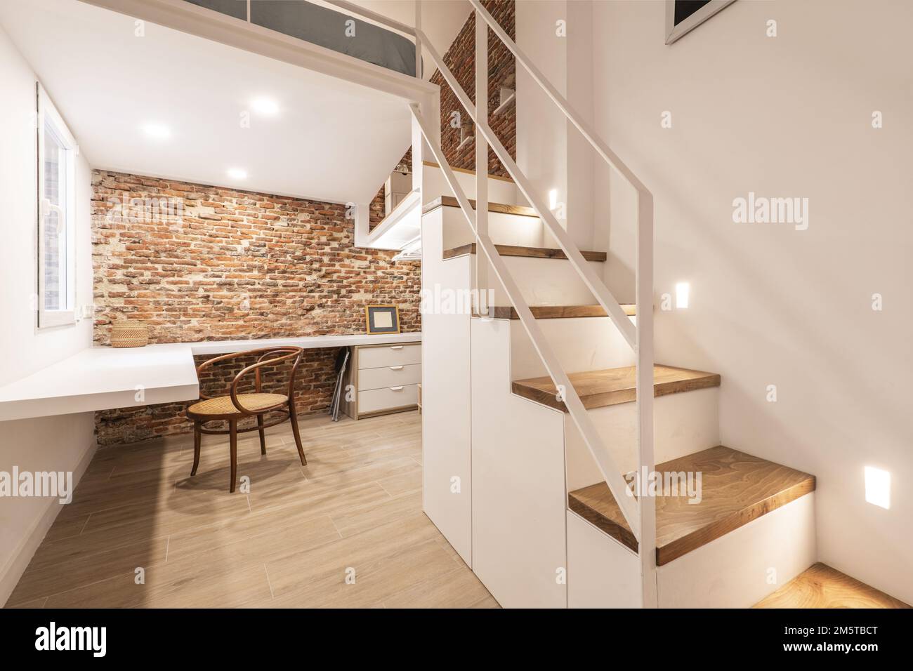A loft house with a staircase with wooden steps and a hole used with ...