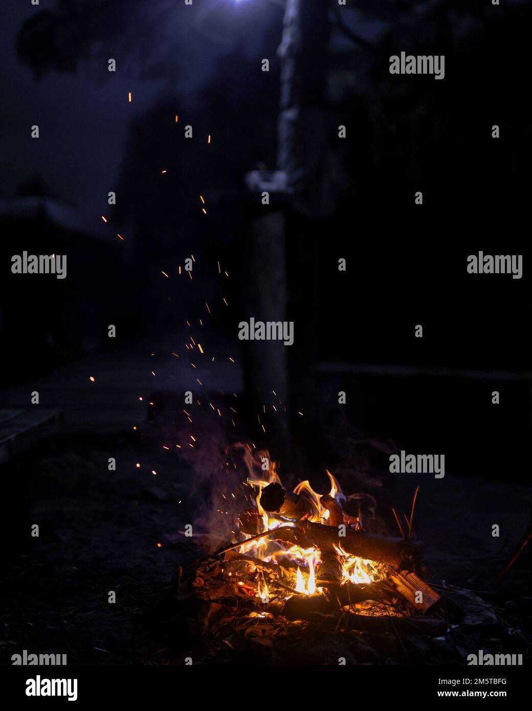 A campfire burning outdoors in darkness Stock Photo - Alamy