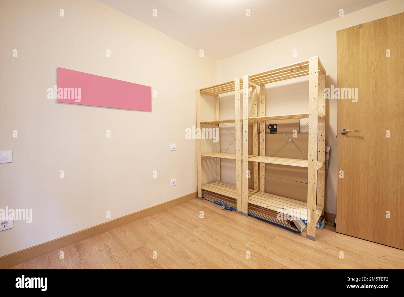 An empty room with empty cargo shelves made of unvarnished wood and ...