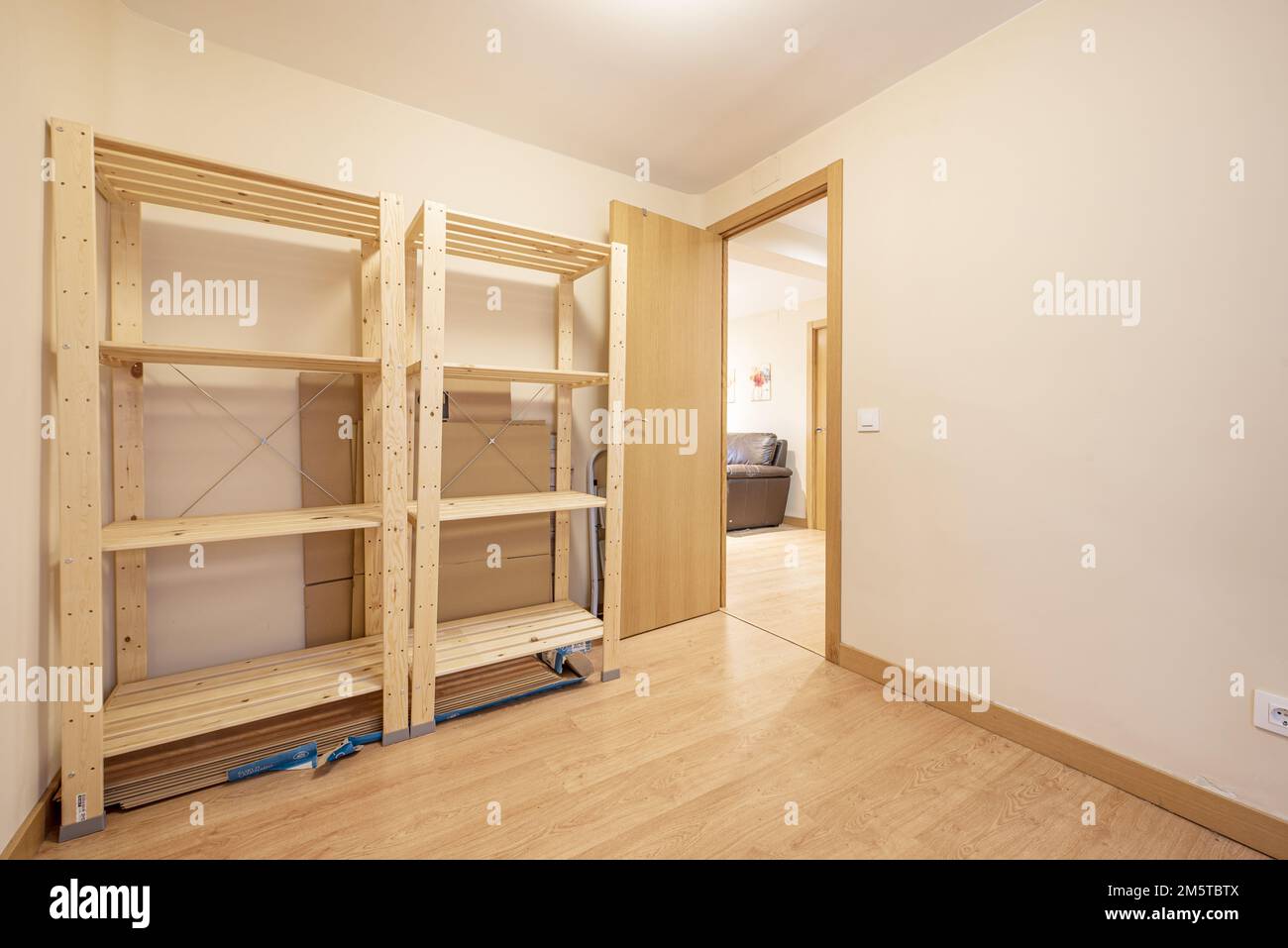 An empty room with empty cargo shelves made of unvarnished wood and a ...