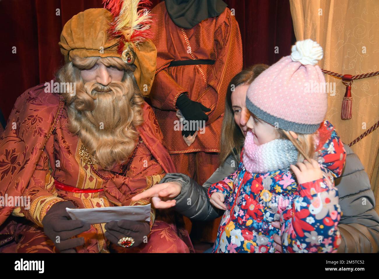 A girl delivers a letter detailing the gifts he wants to receive to the ...