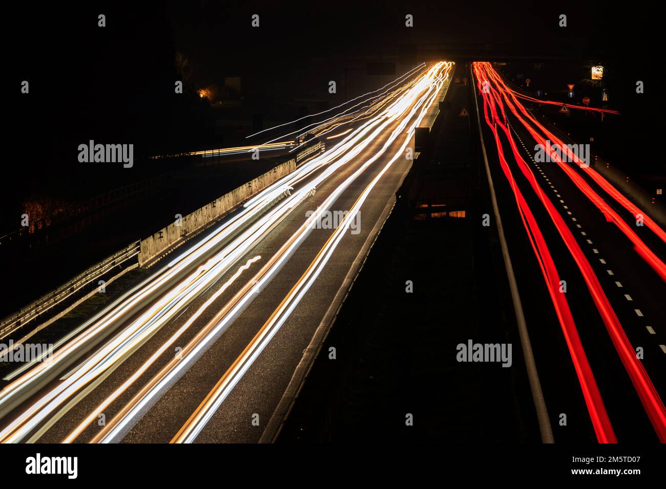Cars light trails at night in curve asphalt road. Long exposure showing ...