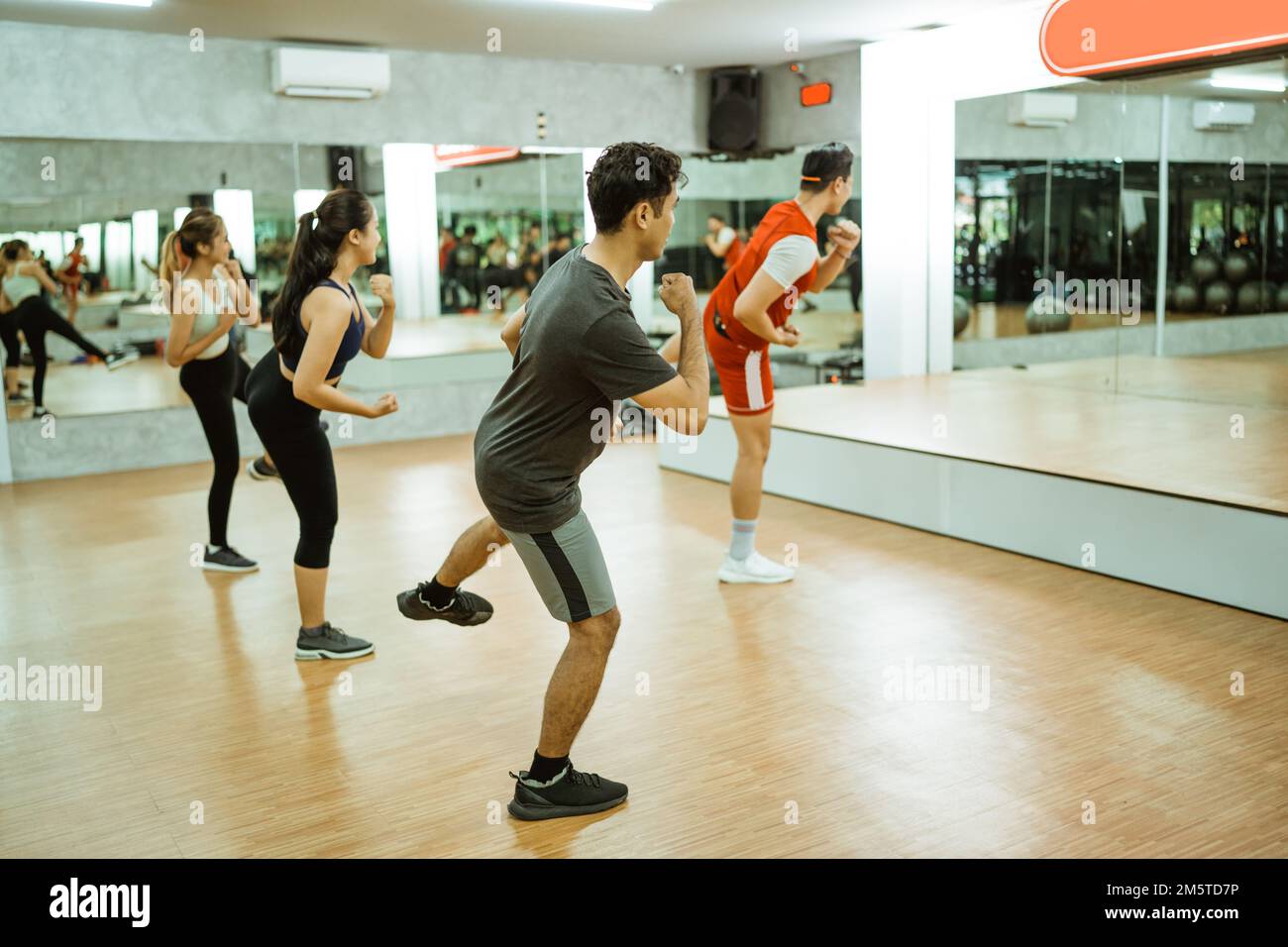 instructor performs with the group in front of the mirror Stock Photo ...