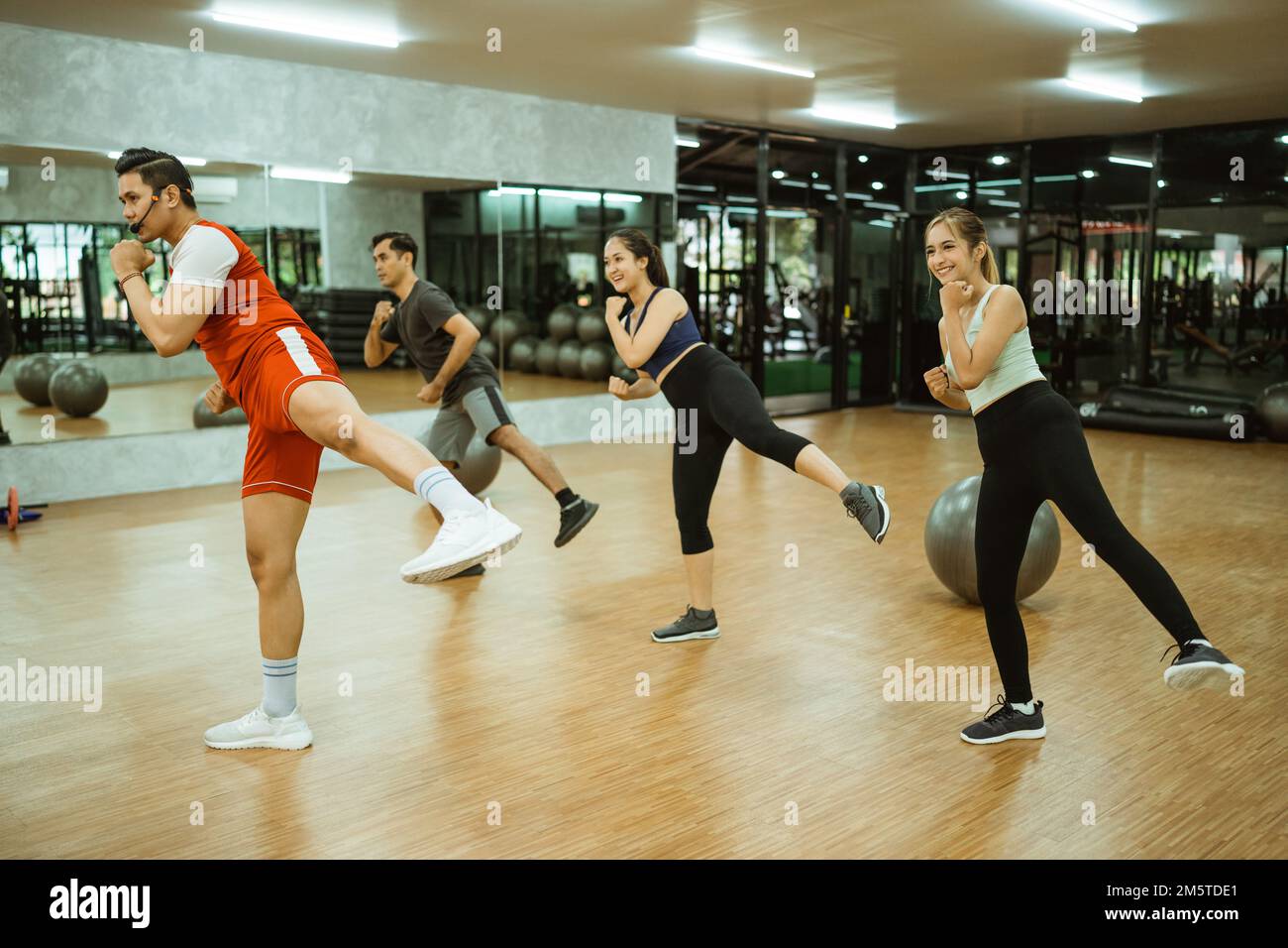 instructor and sporty group doing thigh muscle exercises Stock Photo ...