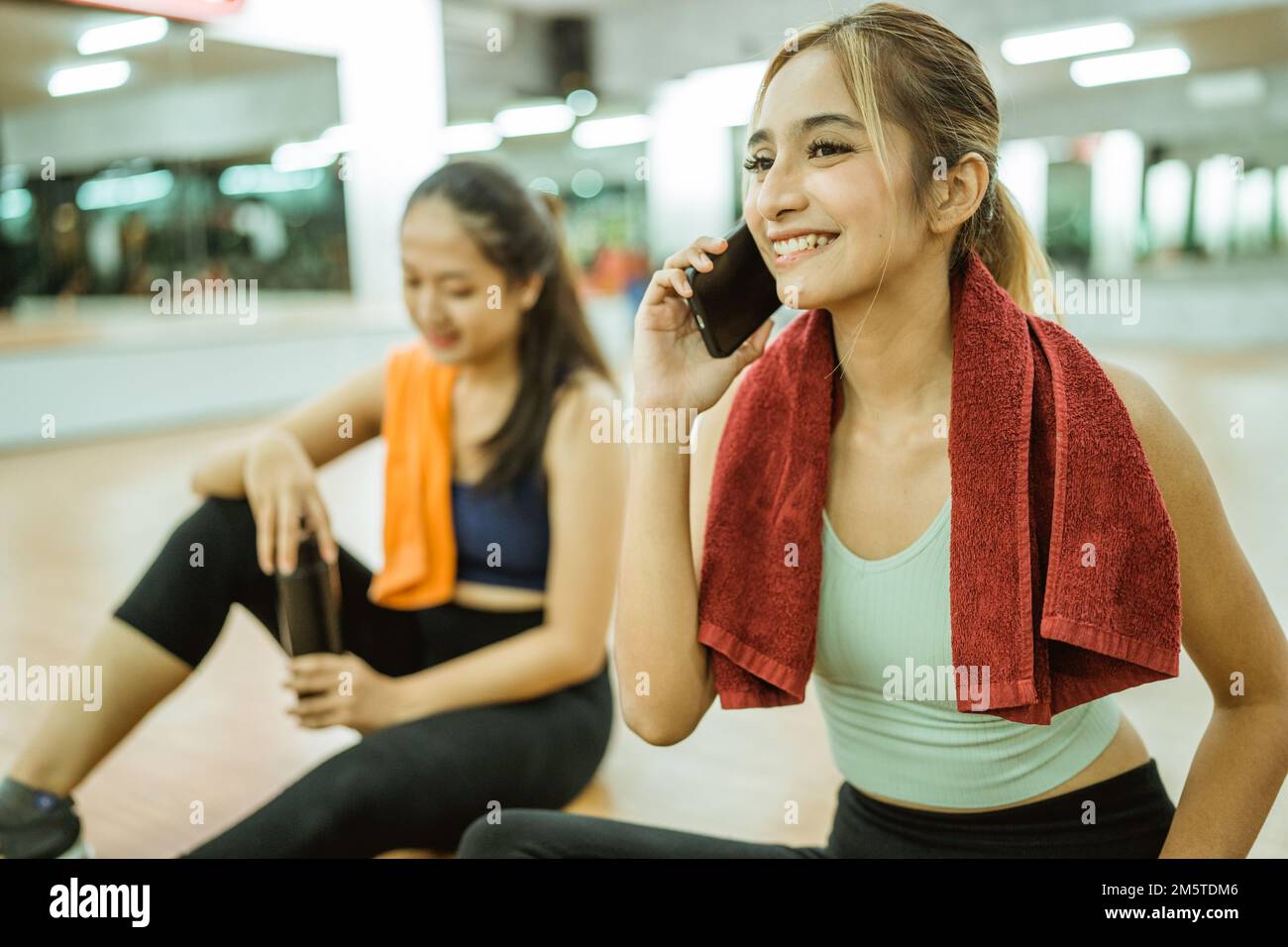 fit young adult woman making cell phone call during break Stock Photo ...