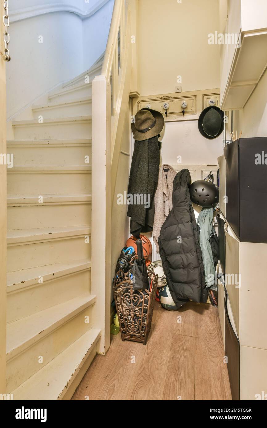 the inside of a house with clothes and bags on the floor in front of ...