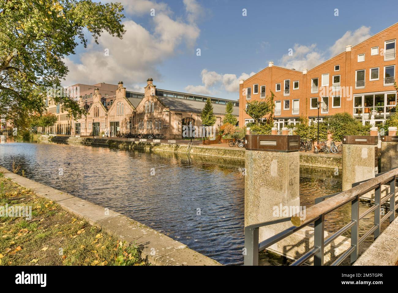 a canal with buildings in the background and water on both sides, as ...