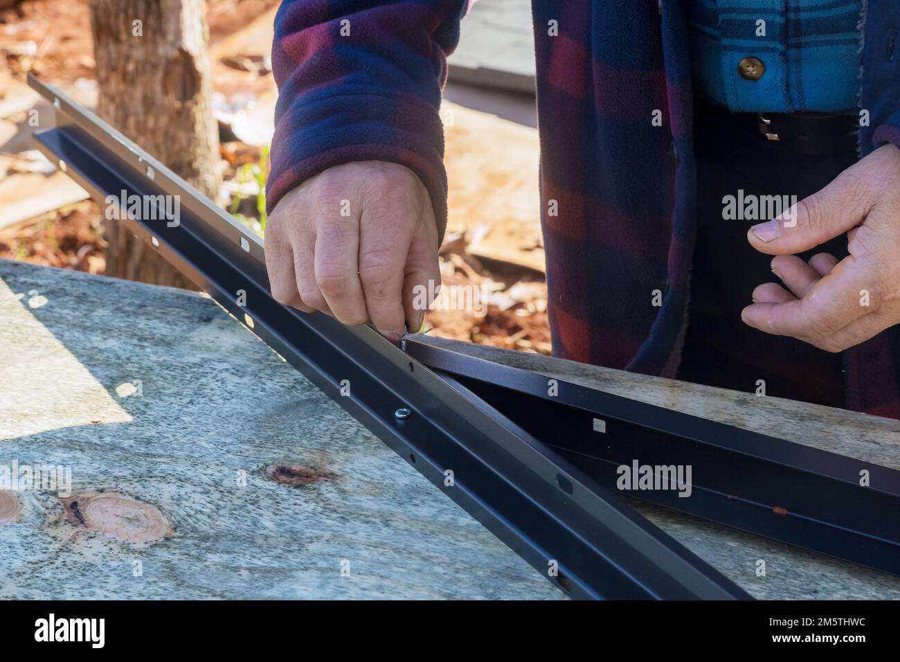 Assembling together plastic shed for in back yard Stock Photo - Alamy