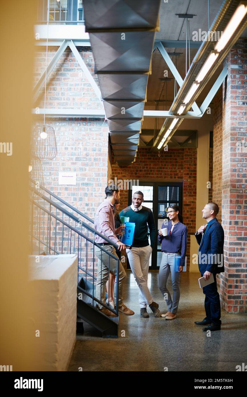 Successful people build each other up. a group of businesspeople having ...