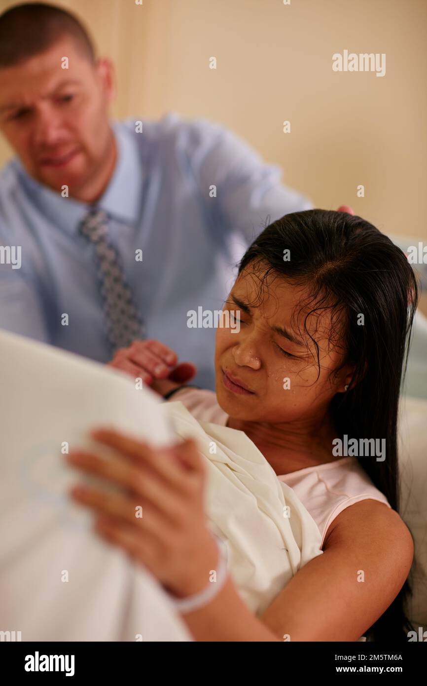Childbirth is an act of nature. a young woman giving birth with her ...
