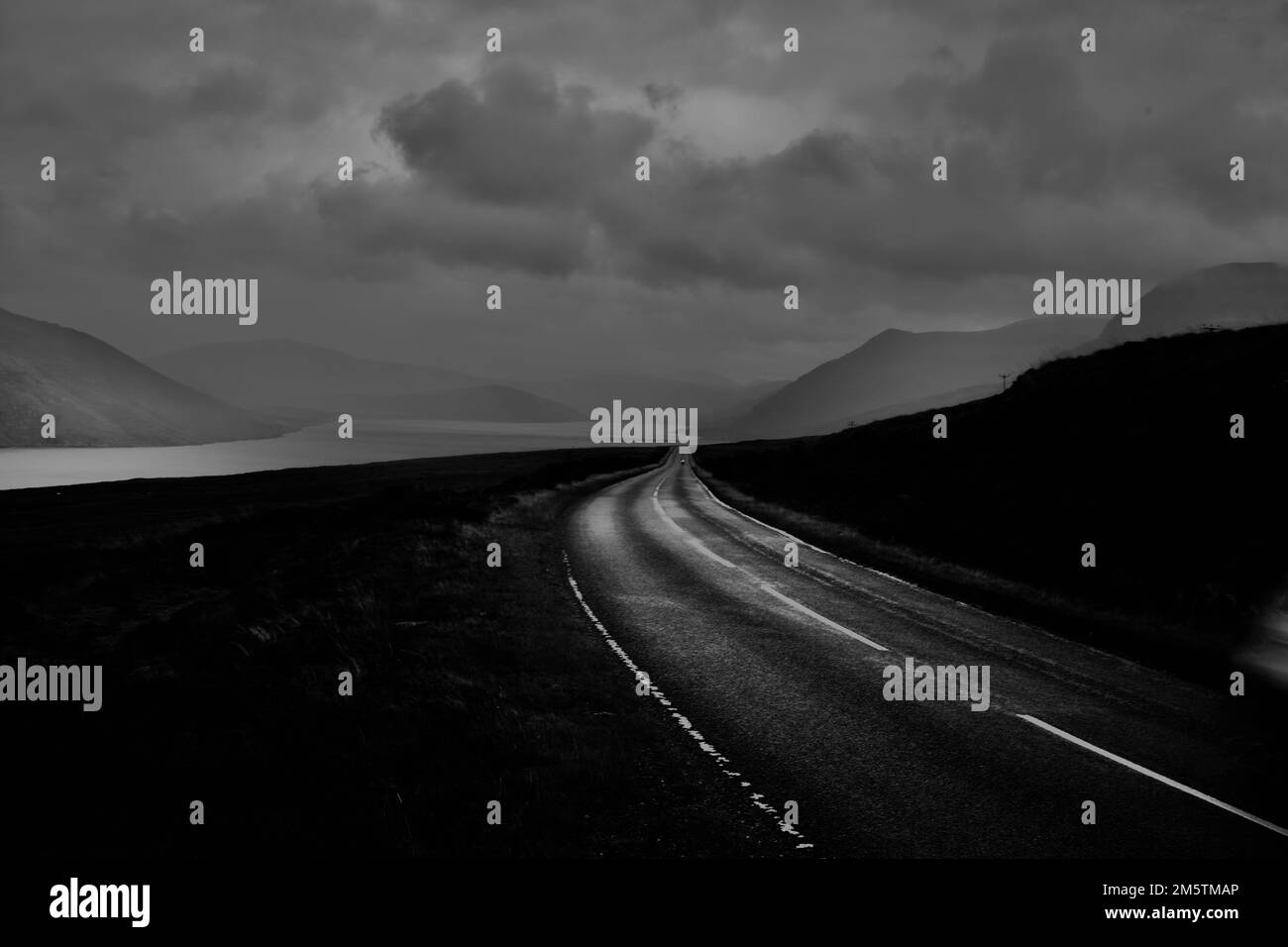 Asphalt road rocky mountains Black and White Stock Photos & Images - Alamy
