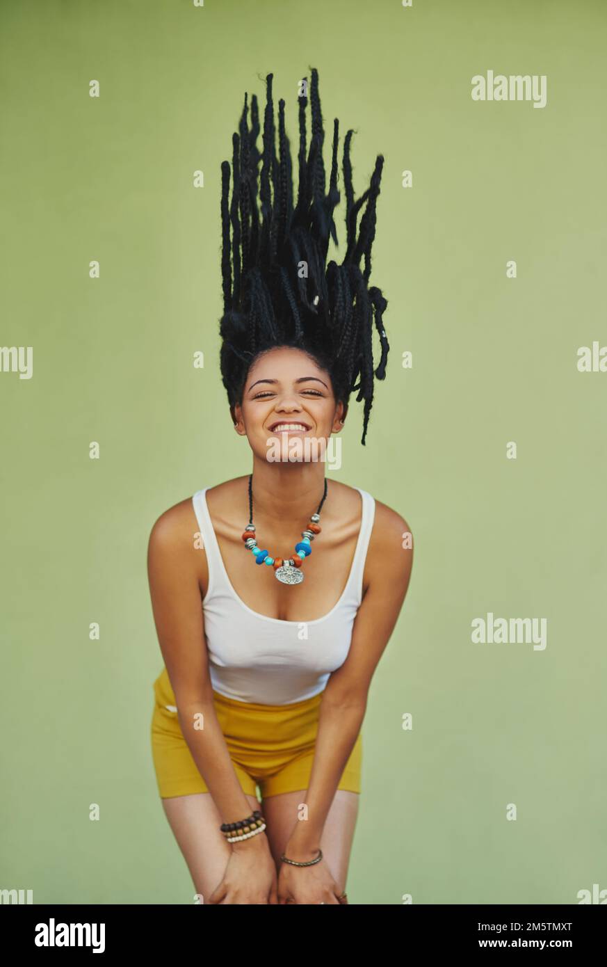 Hair goals. Studio shot of an attractive young woman tossing her hair ...