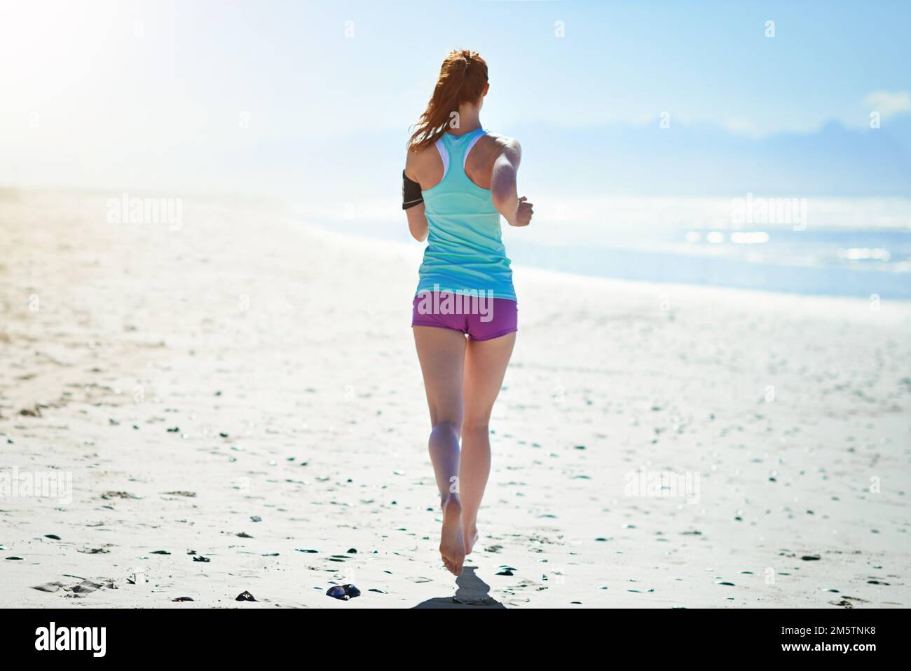 Woman running beach hi-res stock photography and images - Alamy