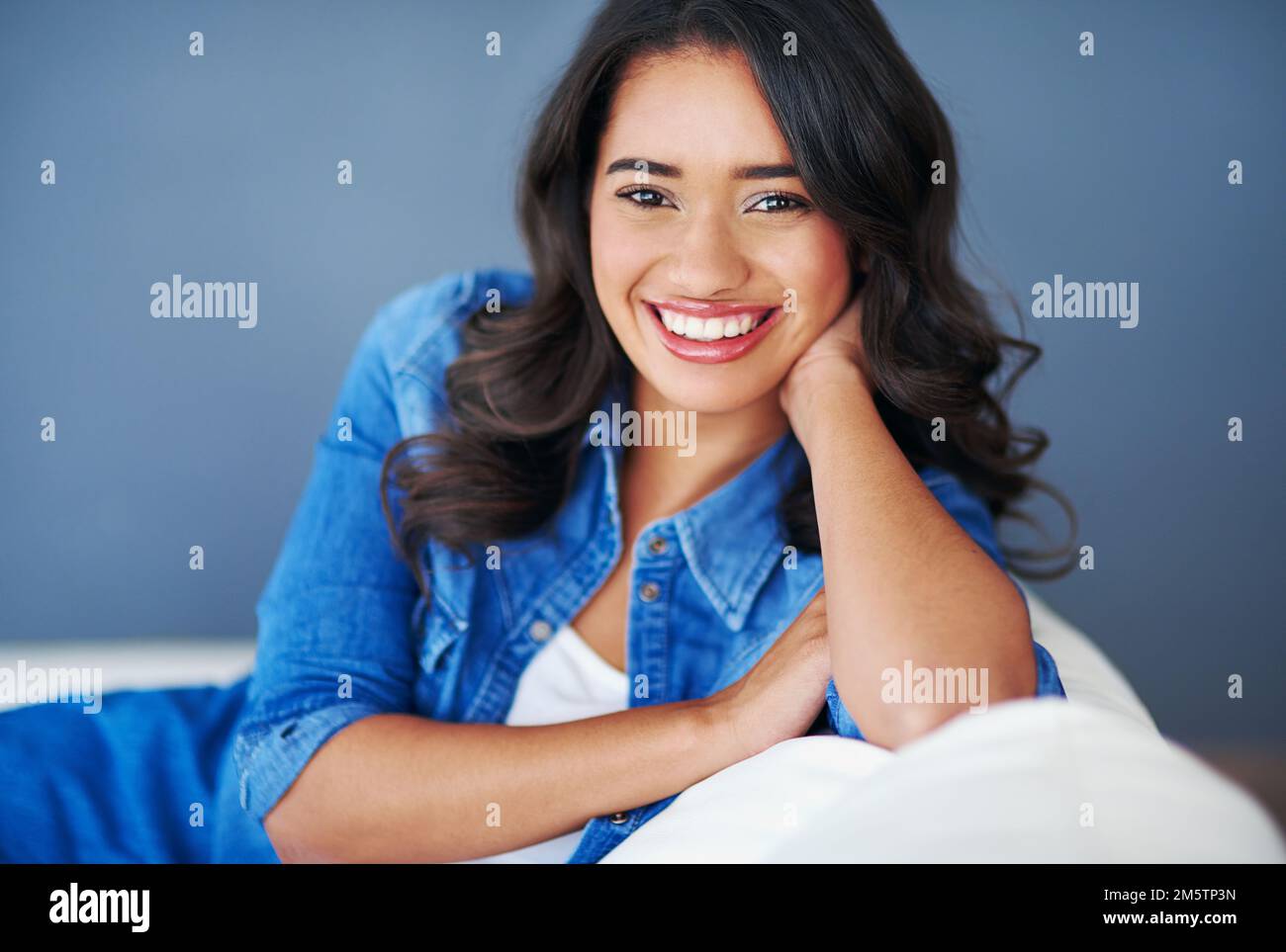 Lounging on the weekend. a young woman relaxing at home on the weekend ...