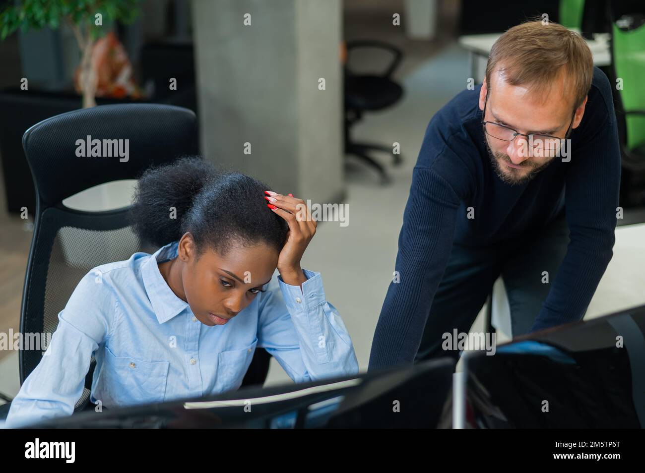 Colleagues look at the monitor and decide working moments. Caucasian ...