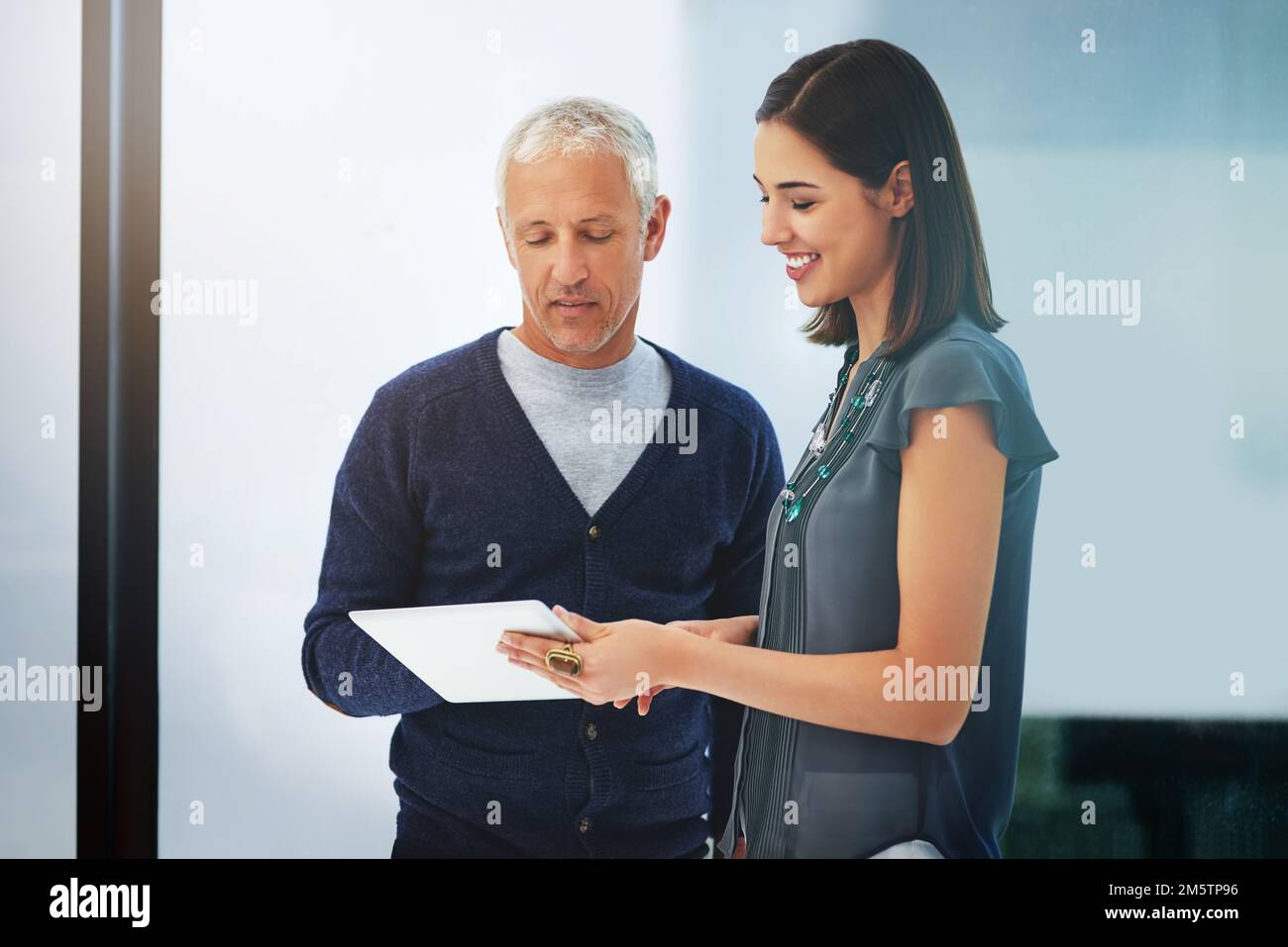 Getting his expert opinion. two colleagues having a conversation over a ...