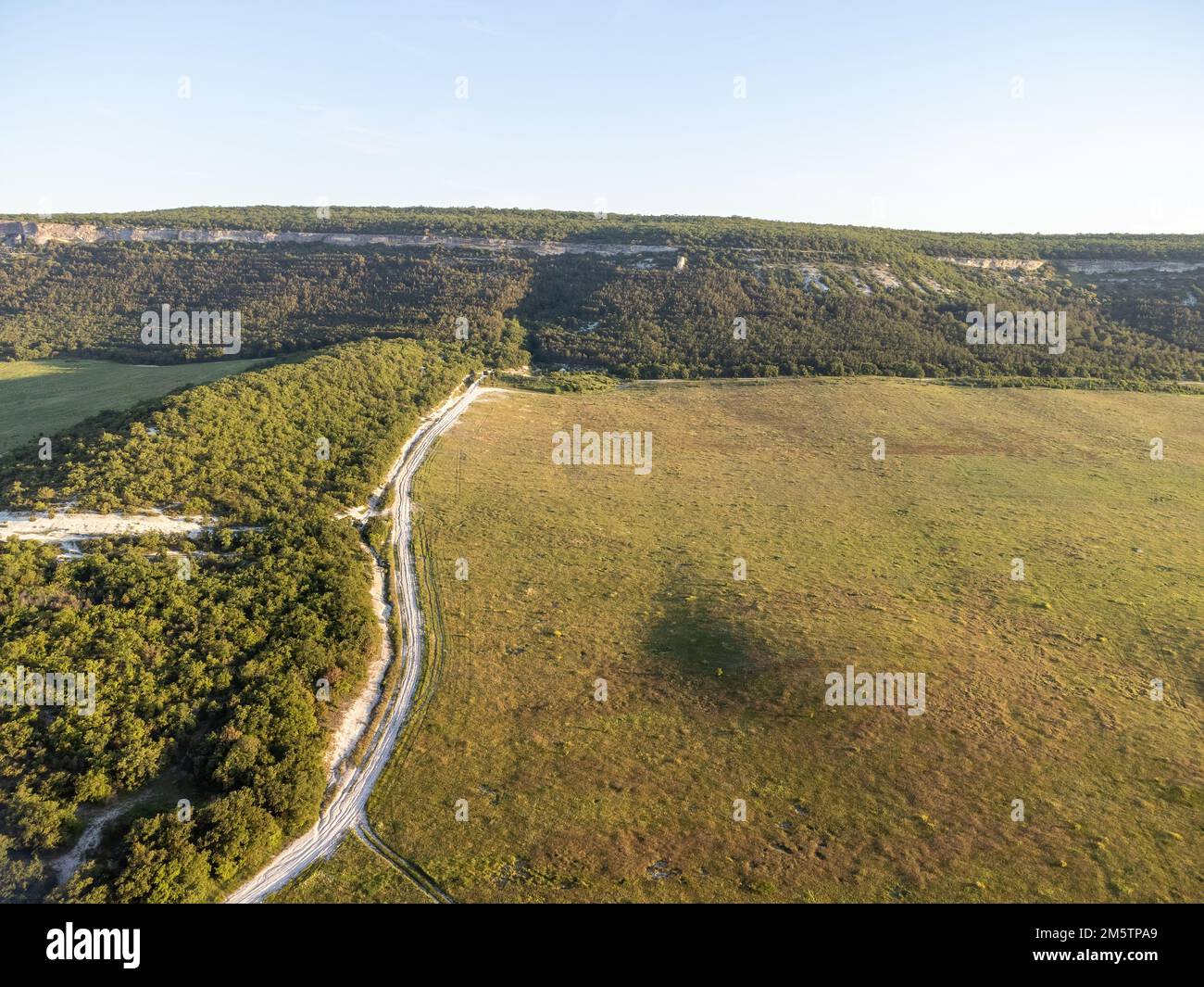 Aerial view on green wheat field, road and hills in countryside. Field ...
