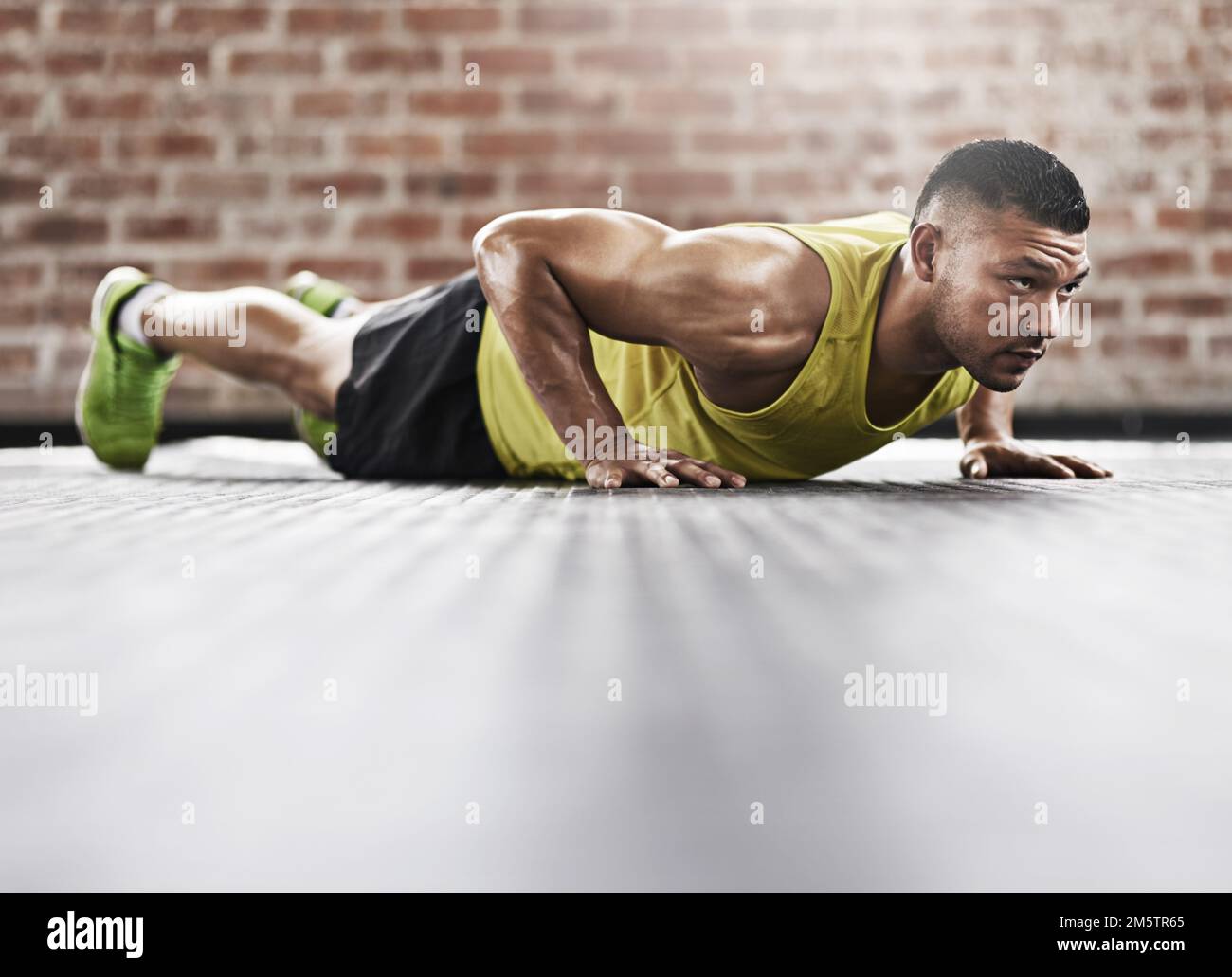 Now thats how you do a pushup. Full length shot of a young man working ...