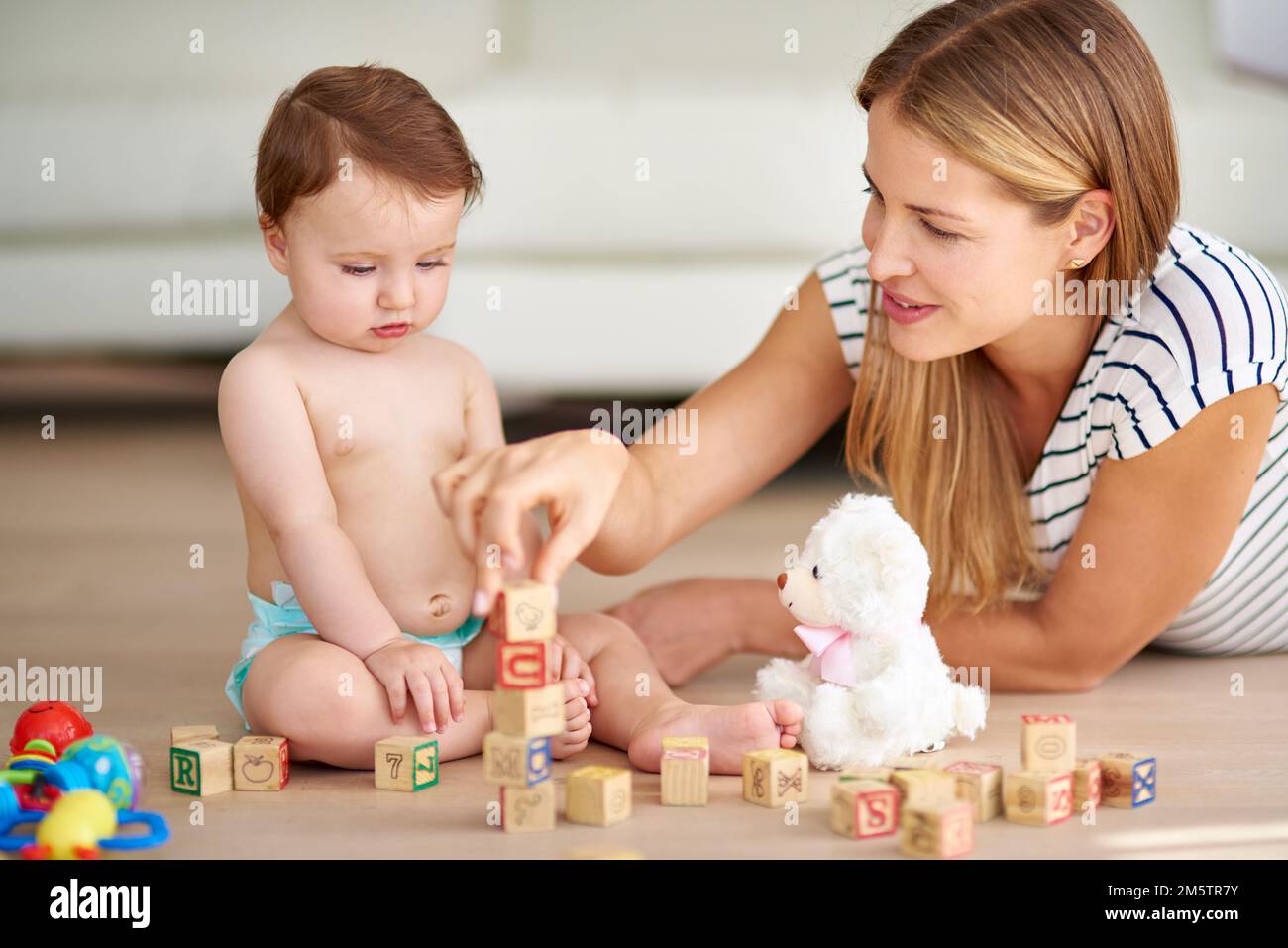 Growing and learning is childs play. an adorable baby girl and her ...
