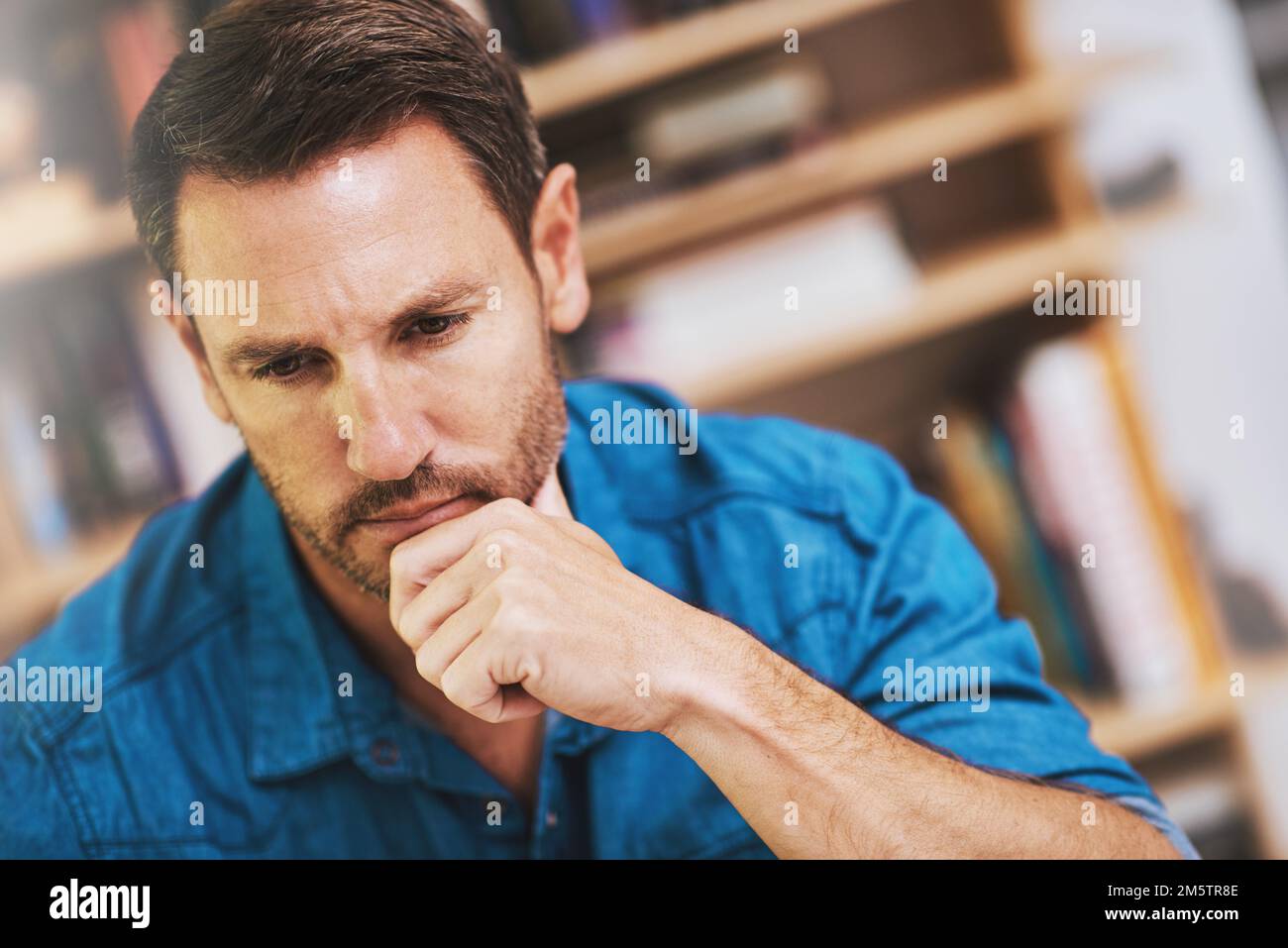 Thinking it through. a businessman looking thoughtful while working at ...