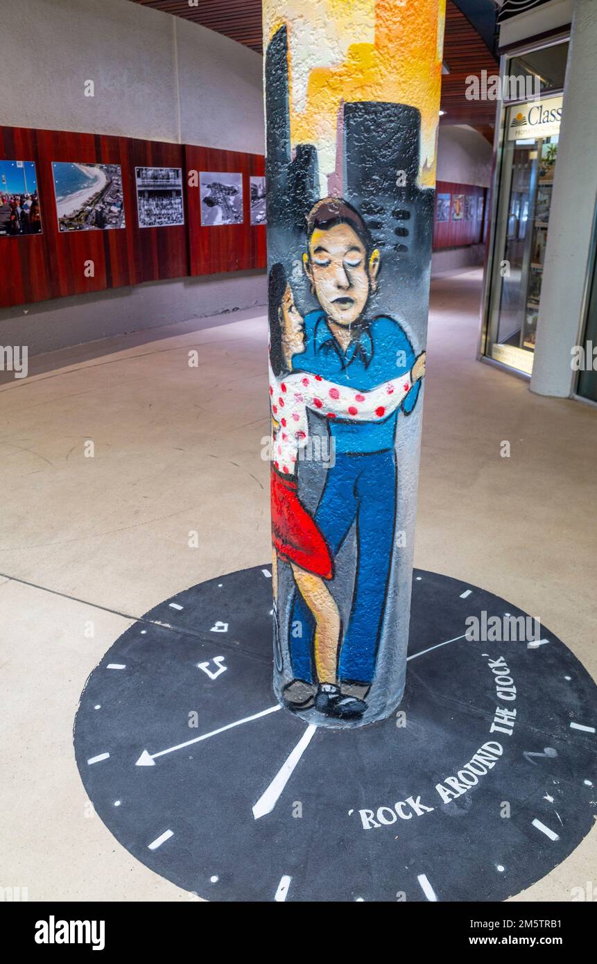 painted mural of dancers rocking around the clock on a column at ...