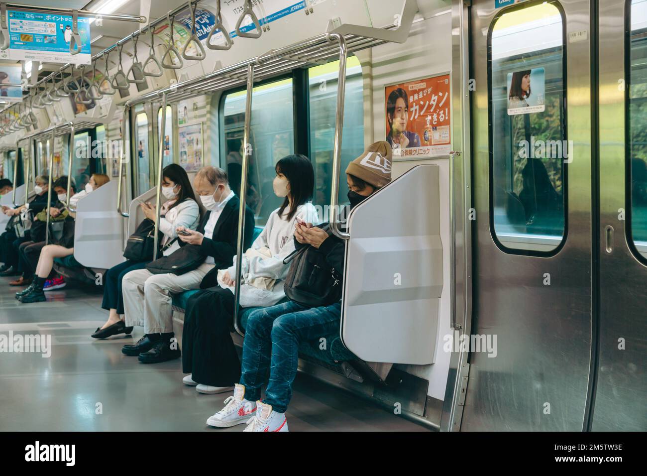 Commuters on the train in Tokyo Stock Photo - Alamy
