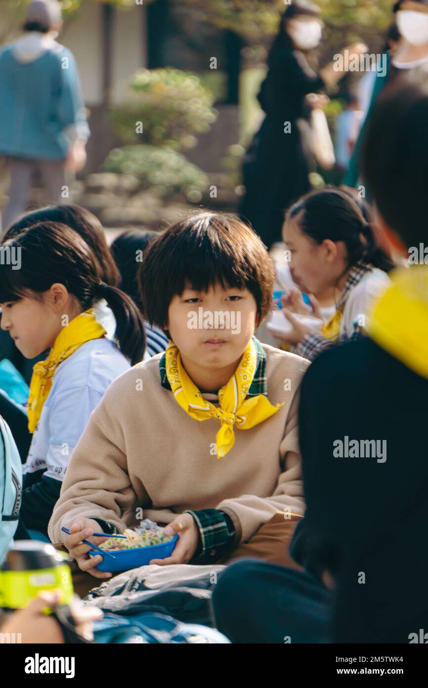 Elementary school students taking a break while on a trip to Sensoji ...