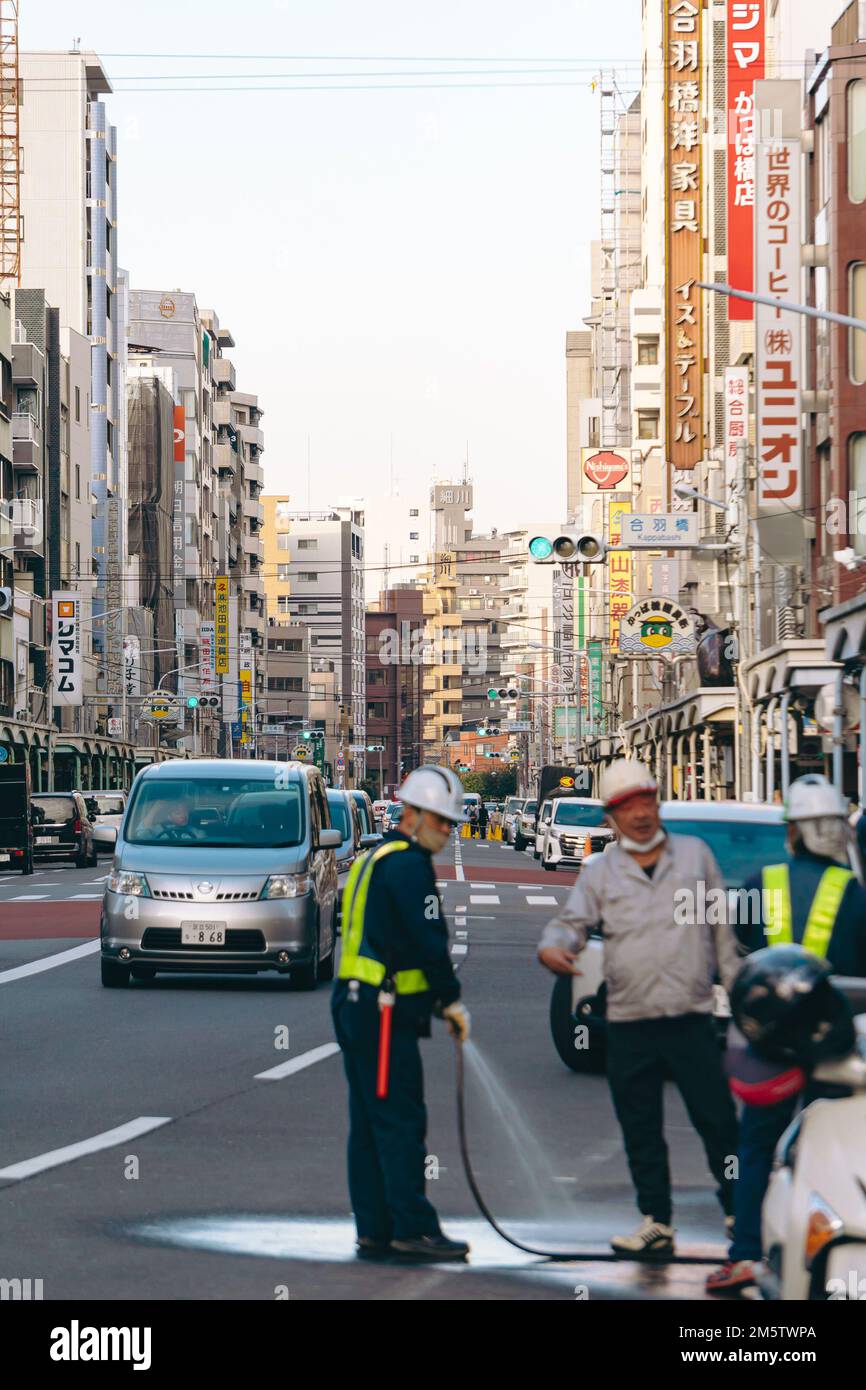 A construction worker working on the streets of downtown Tokyo Stock ...
