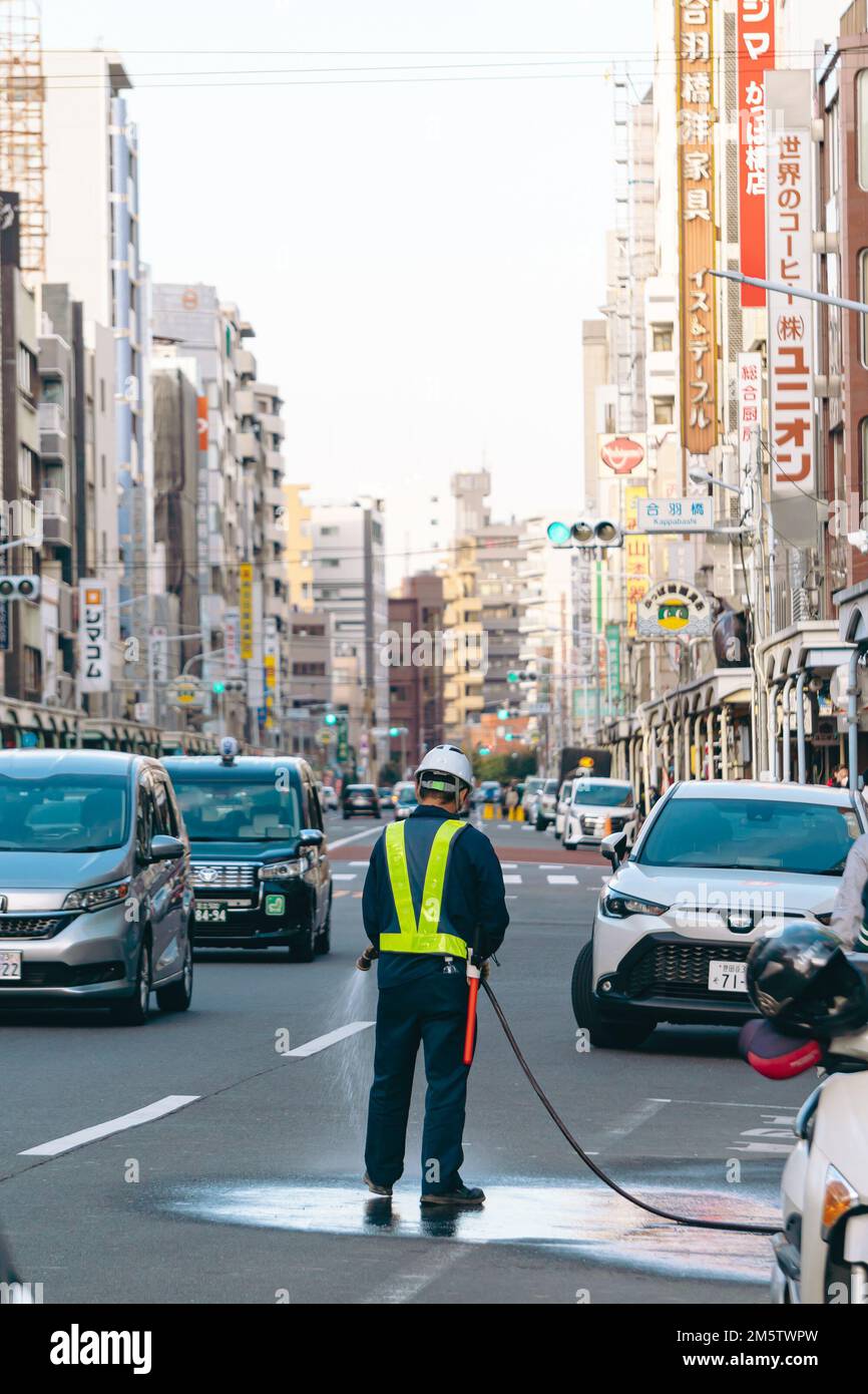 A construction worker working on the streets of downtown Tokyo Stock ...