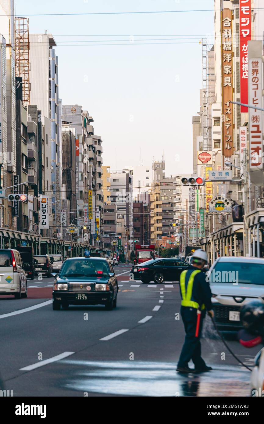 A construction worker working on the streets of downtown Tokyo Stock ...