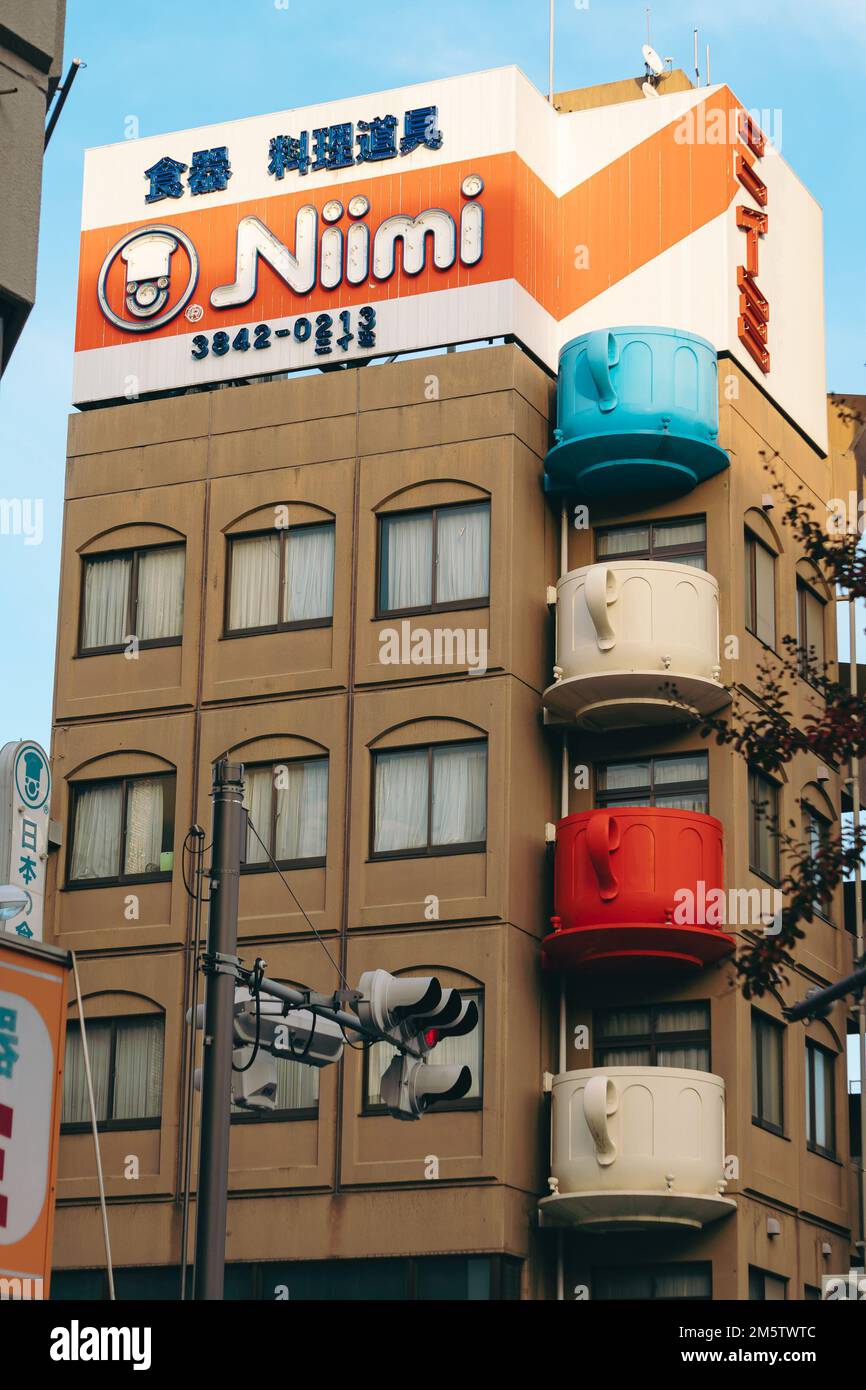 Teacup sculptures on a building facade Stock Photo - Alamy