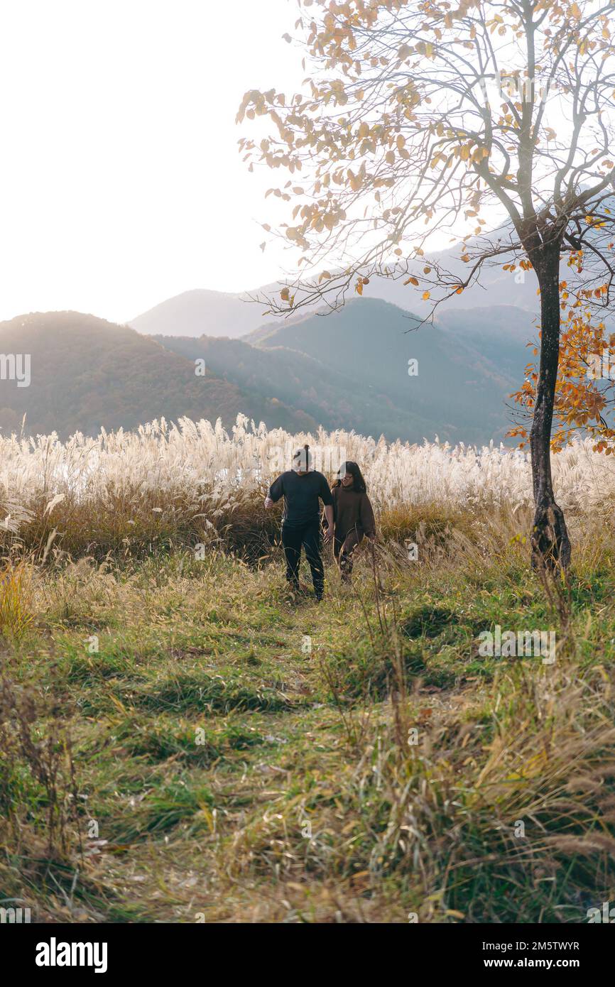 Young couple taking a walk in the outdoors Stock Photo - Alamy