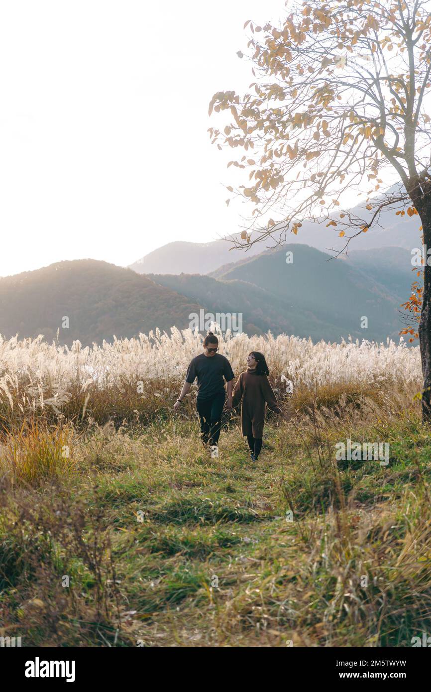 Young couple taking a walk in the outdoors Stock Photo - Alamy