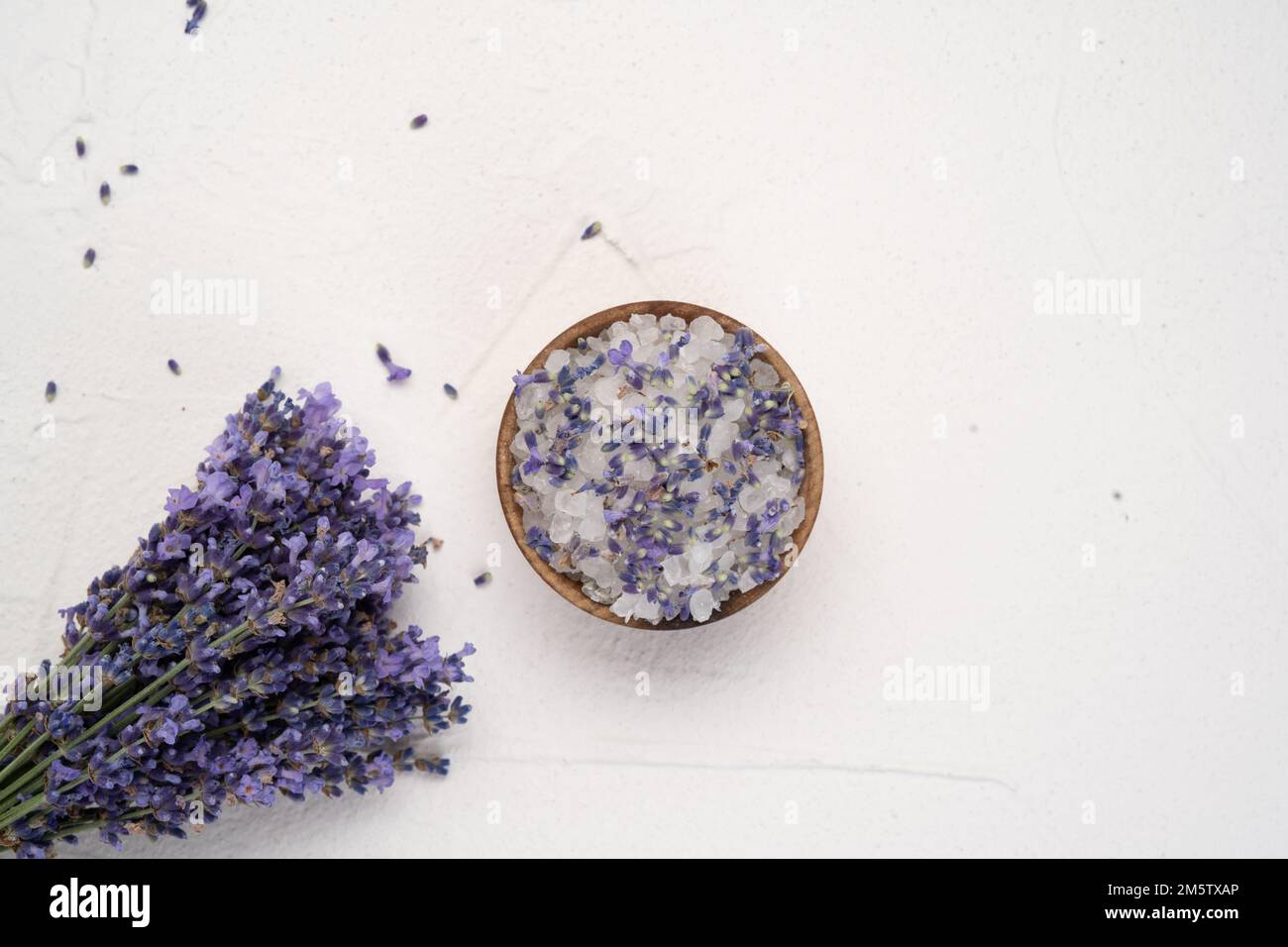 Lavender and sea salt in wooden bowl isolated on white background. Spa ...