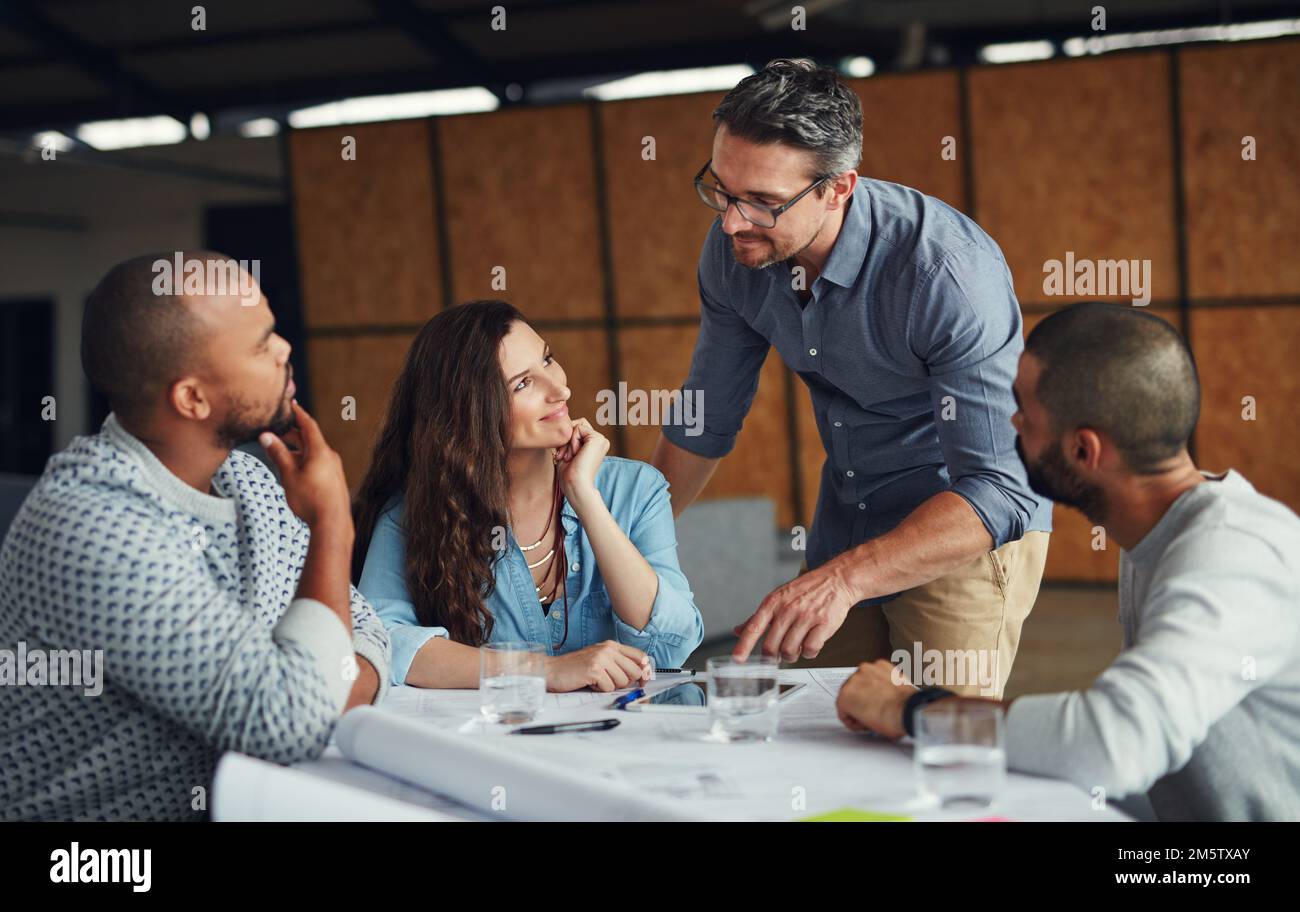 Their success is built on teamwork. a group of coworkers having a ...