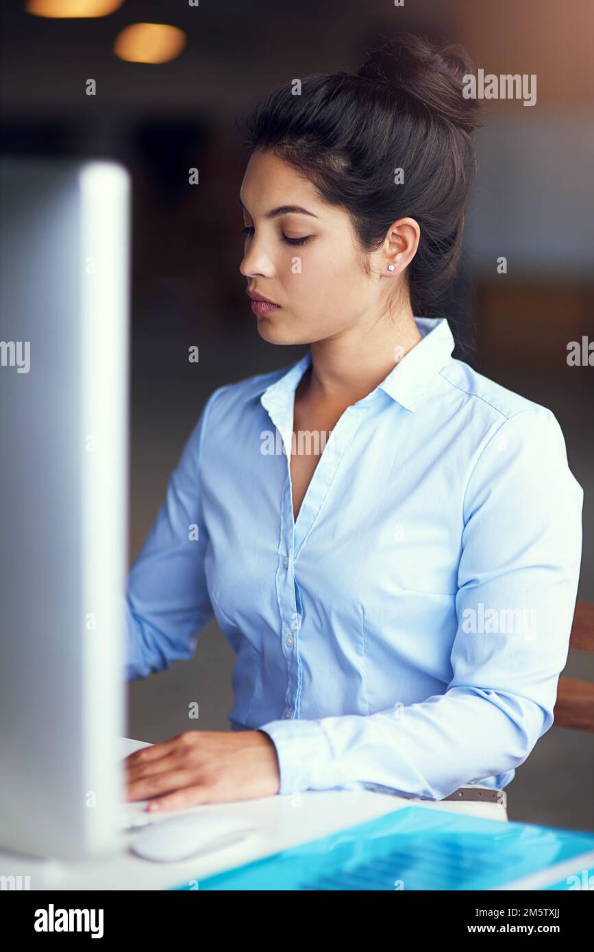 Shes all about efficiency. a young businesswoman working on her office ...