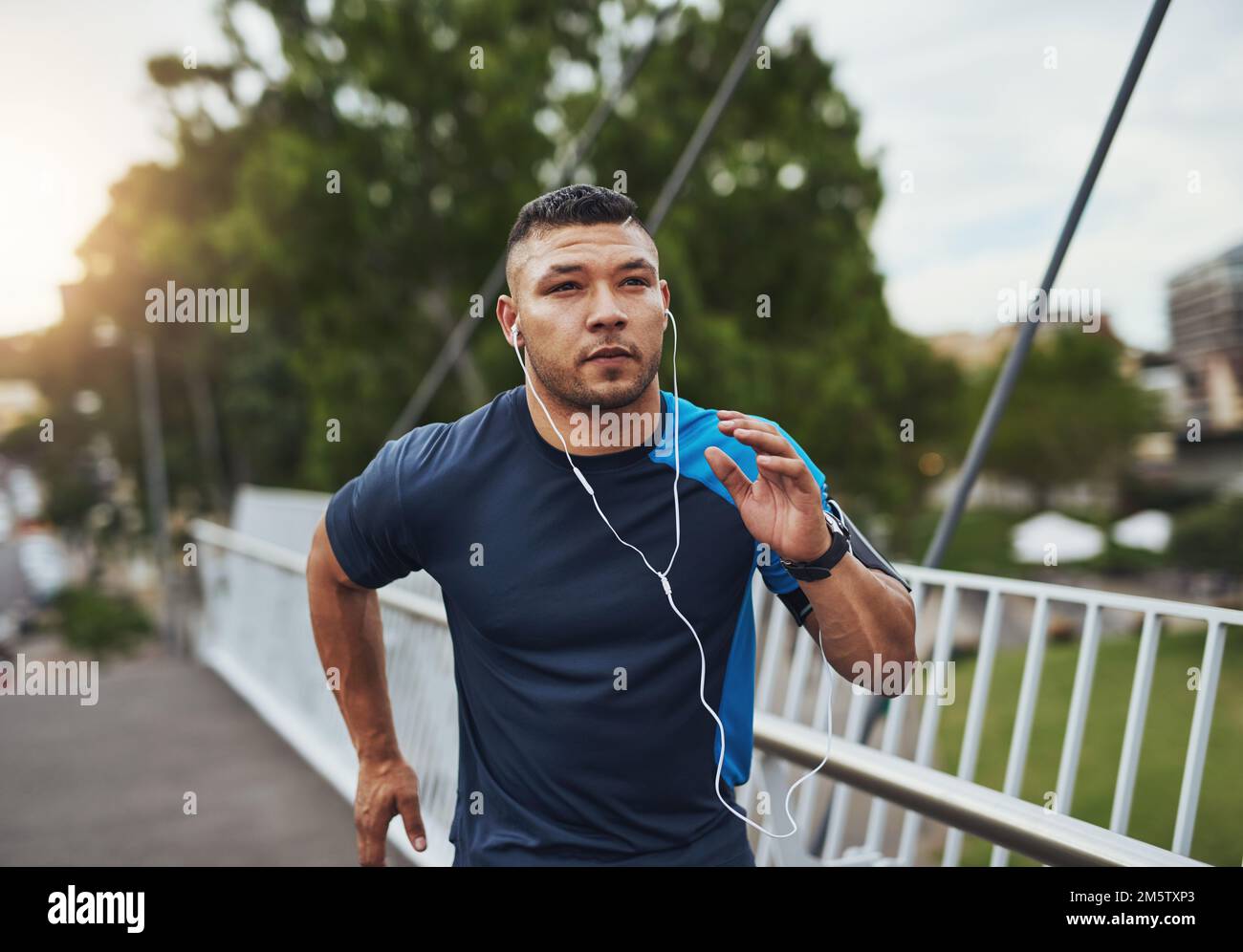 Training hard for an upcoming marathon. a young man out for a run in ...