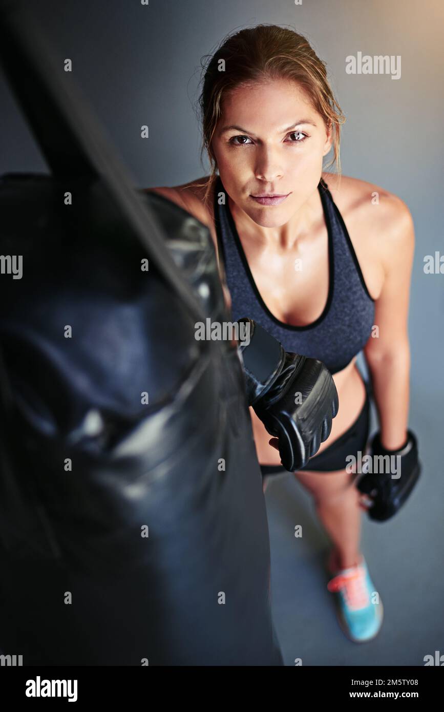 Stronger than your average chick. Portrait of a female boxer leaning ...
