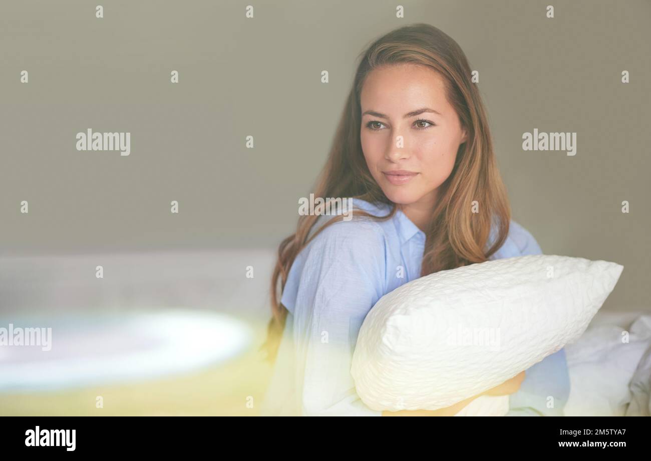 Well rested and ready for the day. an attractive young woman hugging a ...