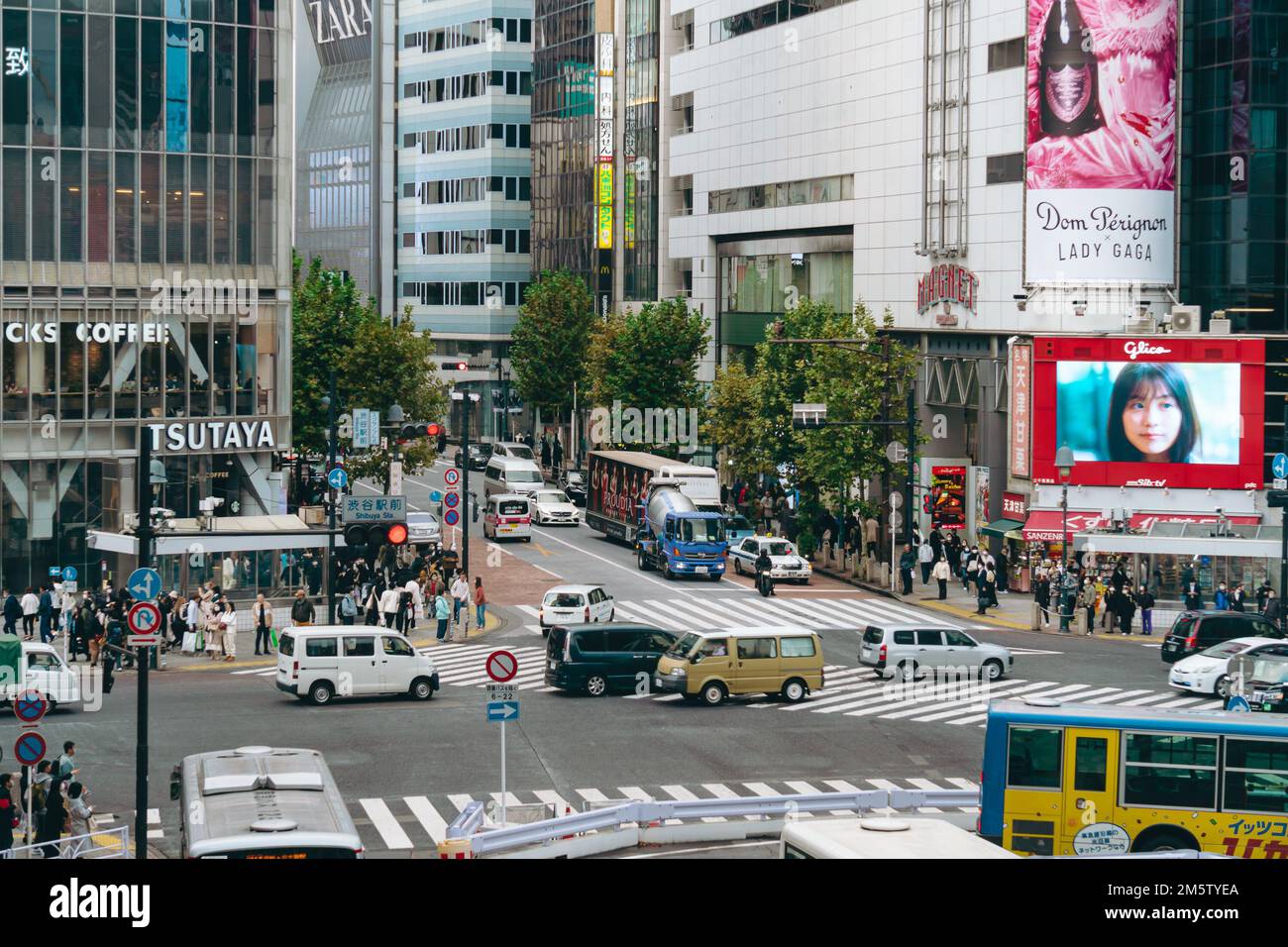 Public Vehicles driving through the Shibuya intersection Stock Photo ...
