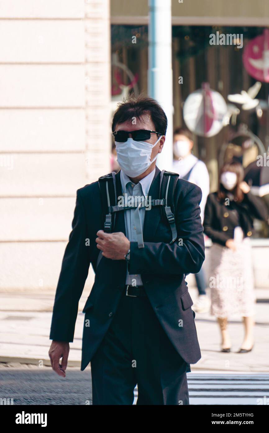 Man in mask in the streets of Ginza Stock Photo - Alamy