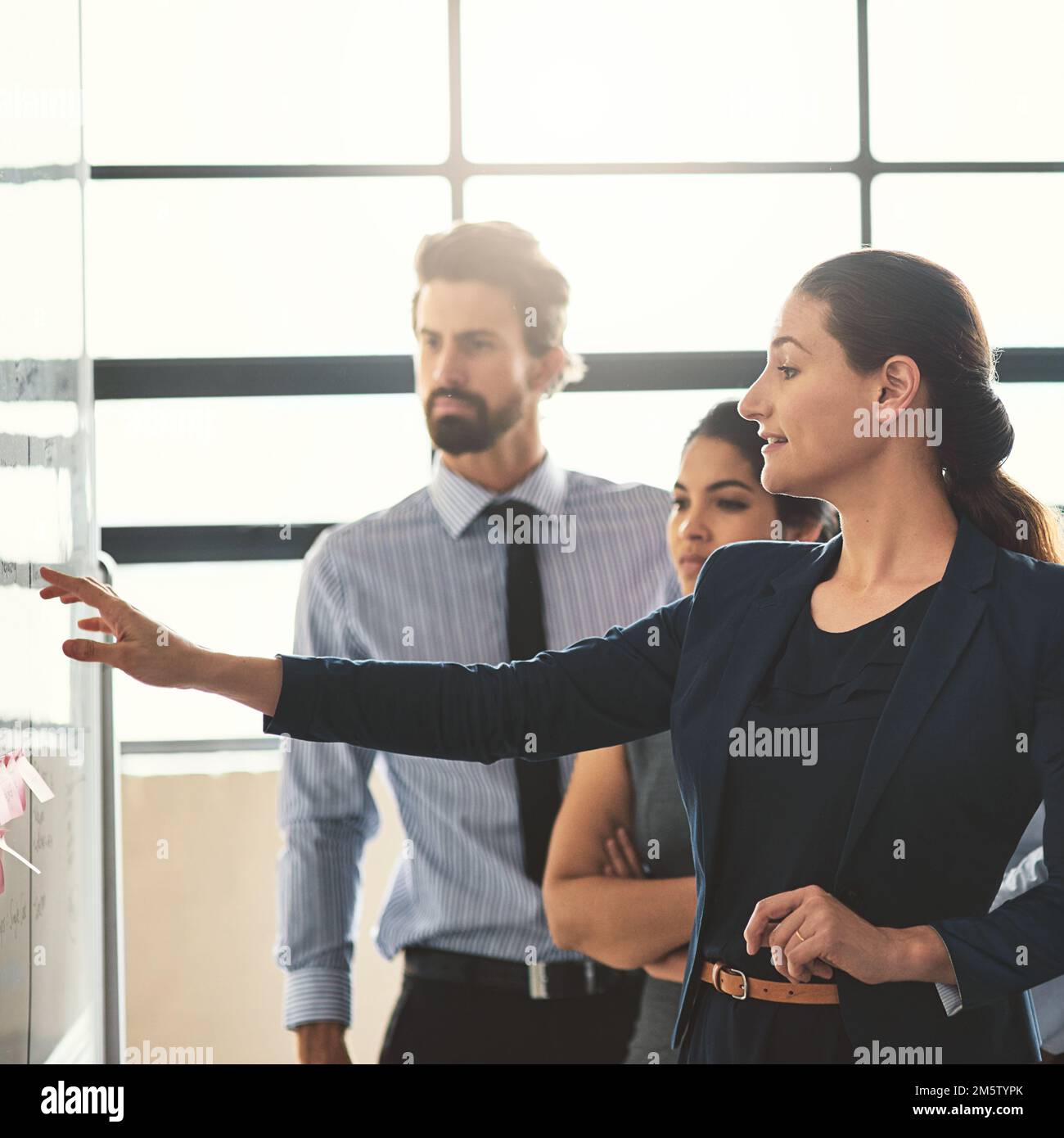 They have a plan in mind...a group of businesspeople looking over plans ...