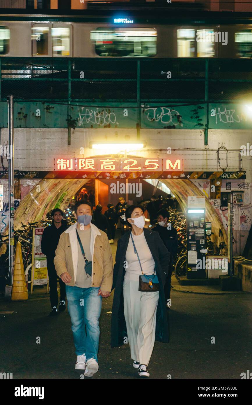 Train passes above a pedestrian tunnel in Shibuya Stock Photo - Alamy