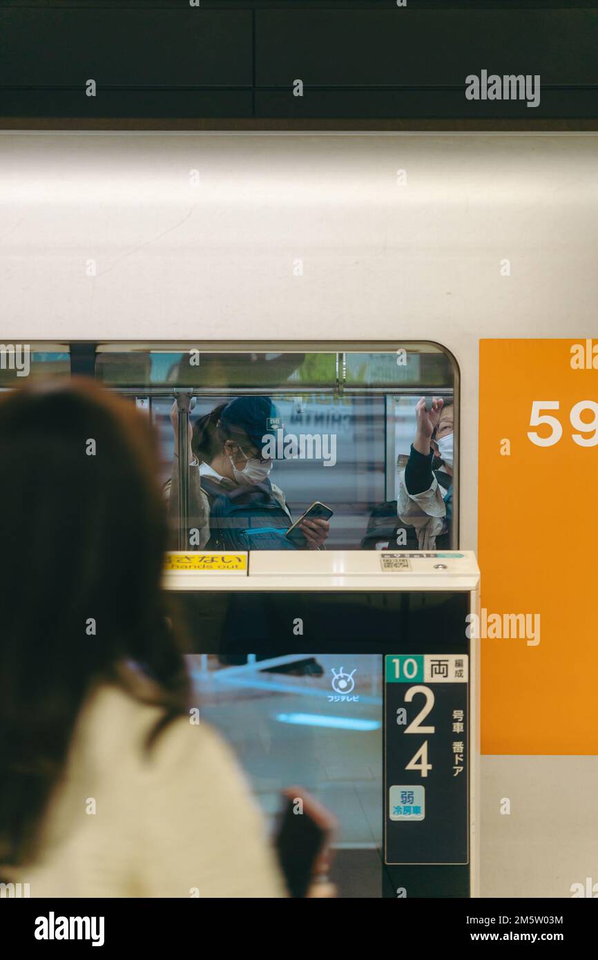 Commuters riding on subway trains in Tokyo Stock Photo - Alamy