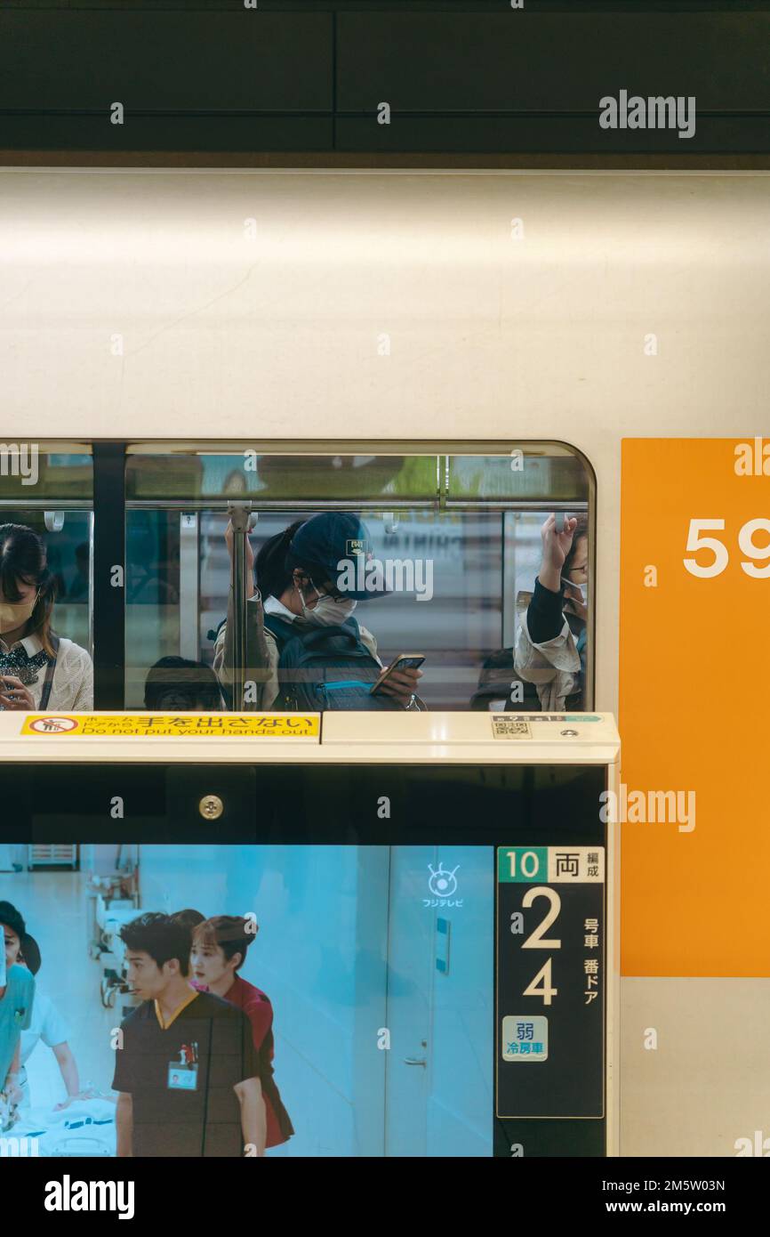 Commuters riding on subway trains in Tokyo Stock Photo - Alamy