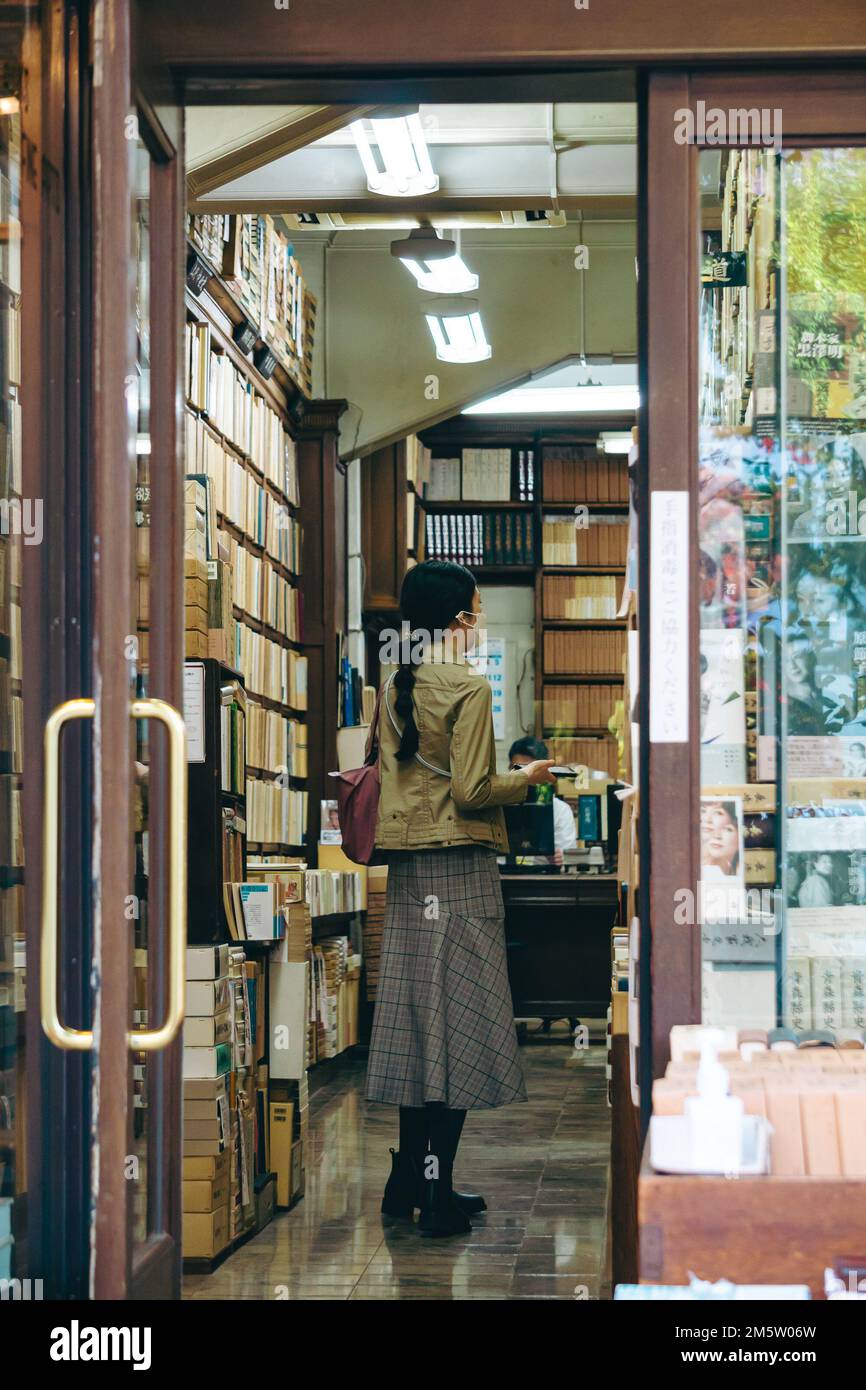 A customer browsing for books at a bookstore Stock Photo - Alamy