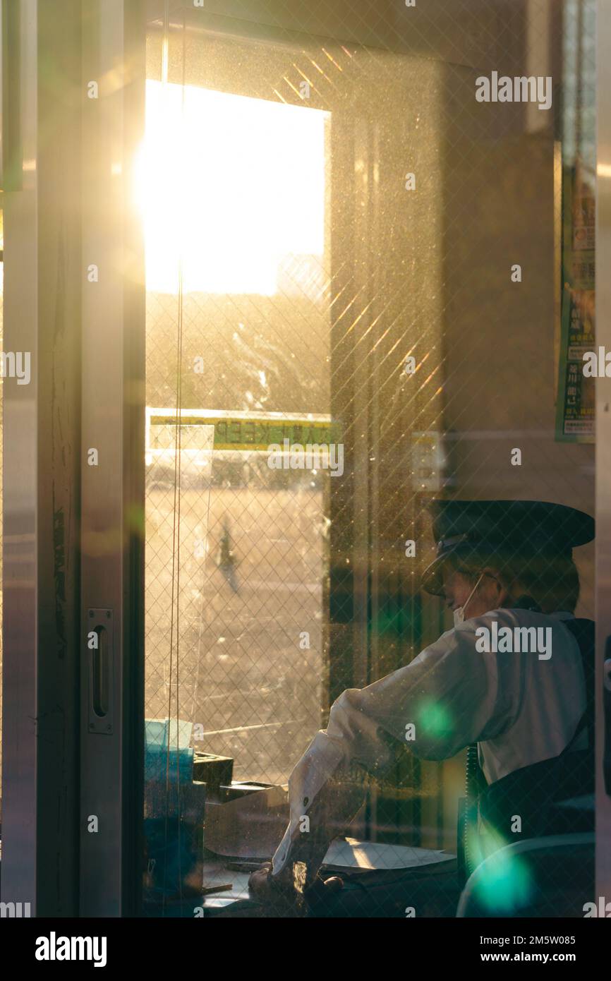 A security guard on duty in a booth Stock Photo - Alamy