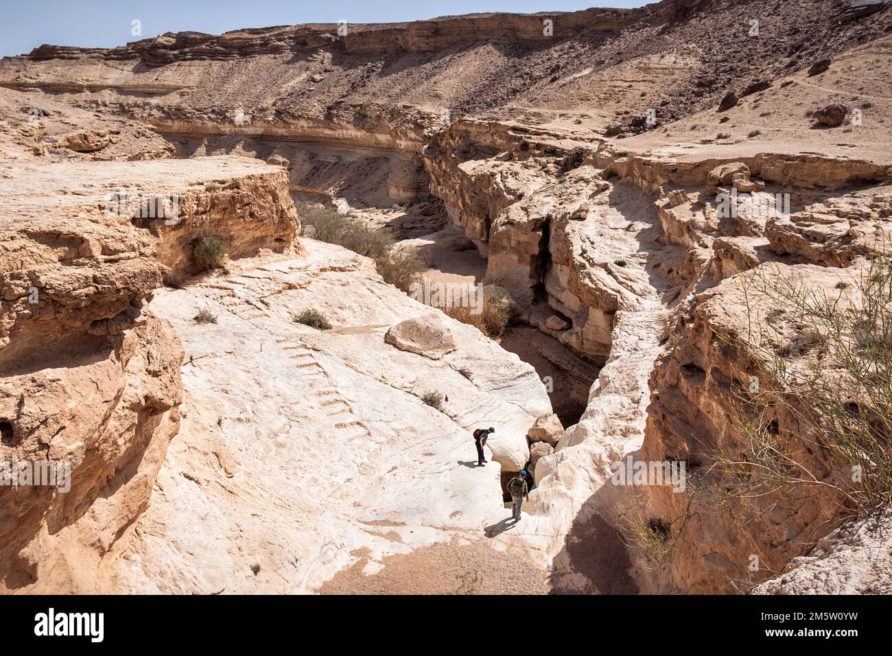 ancient carved stair steps at the Ein Yeruham spring with two hikers ...