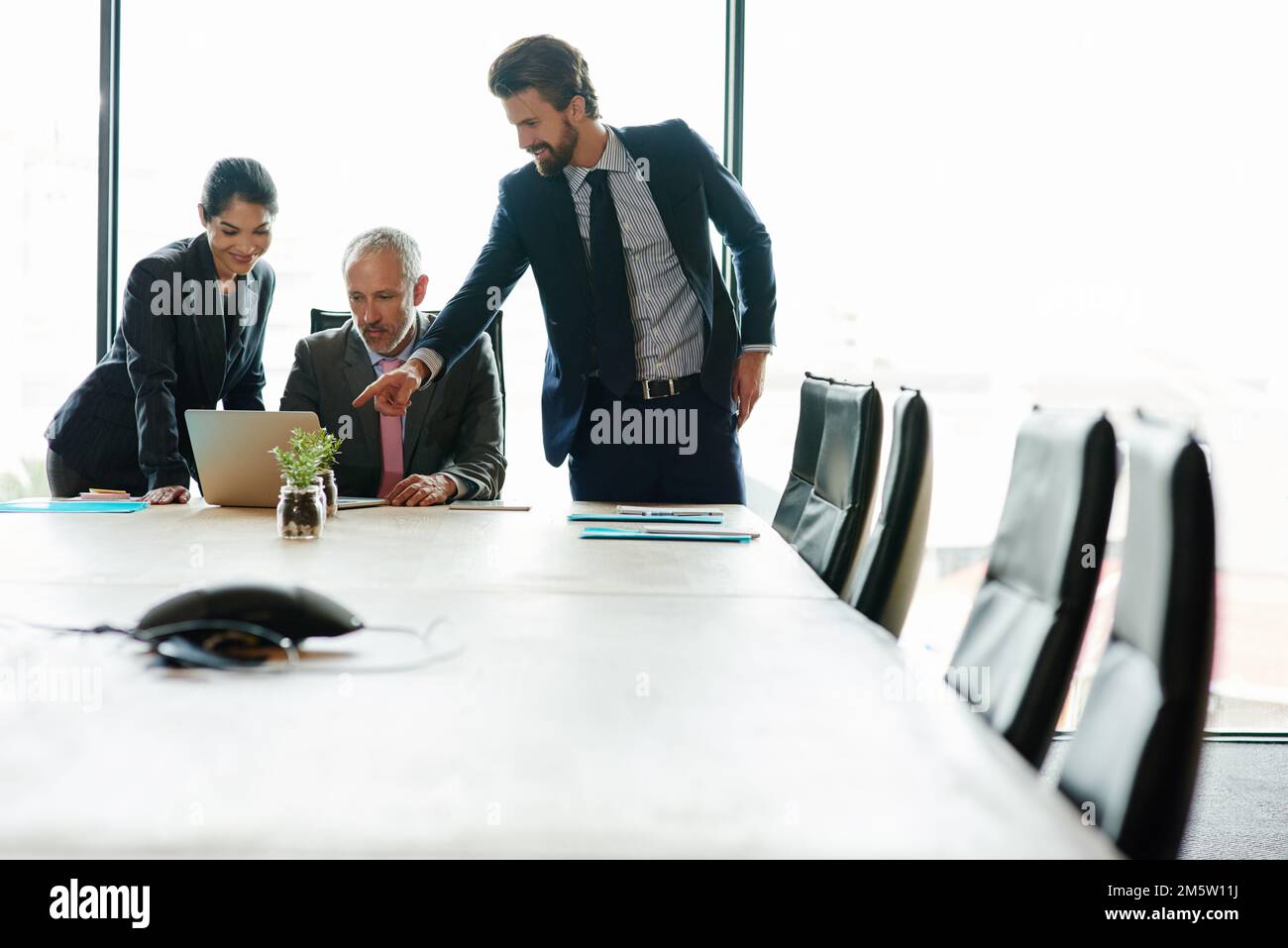 Putting ideas into action. a group of executives having a meeting in a ...