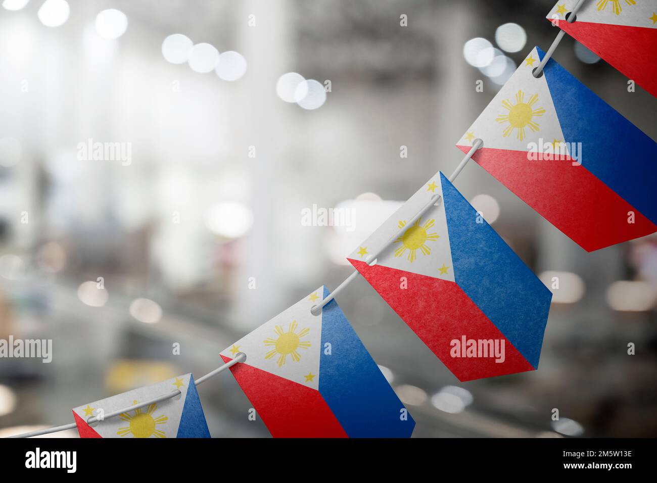 A garland of Philippines national flags on an abstract blurred ...